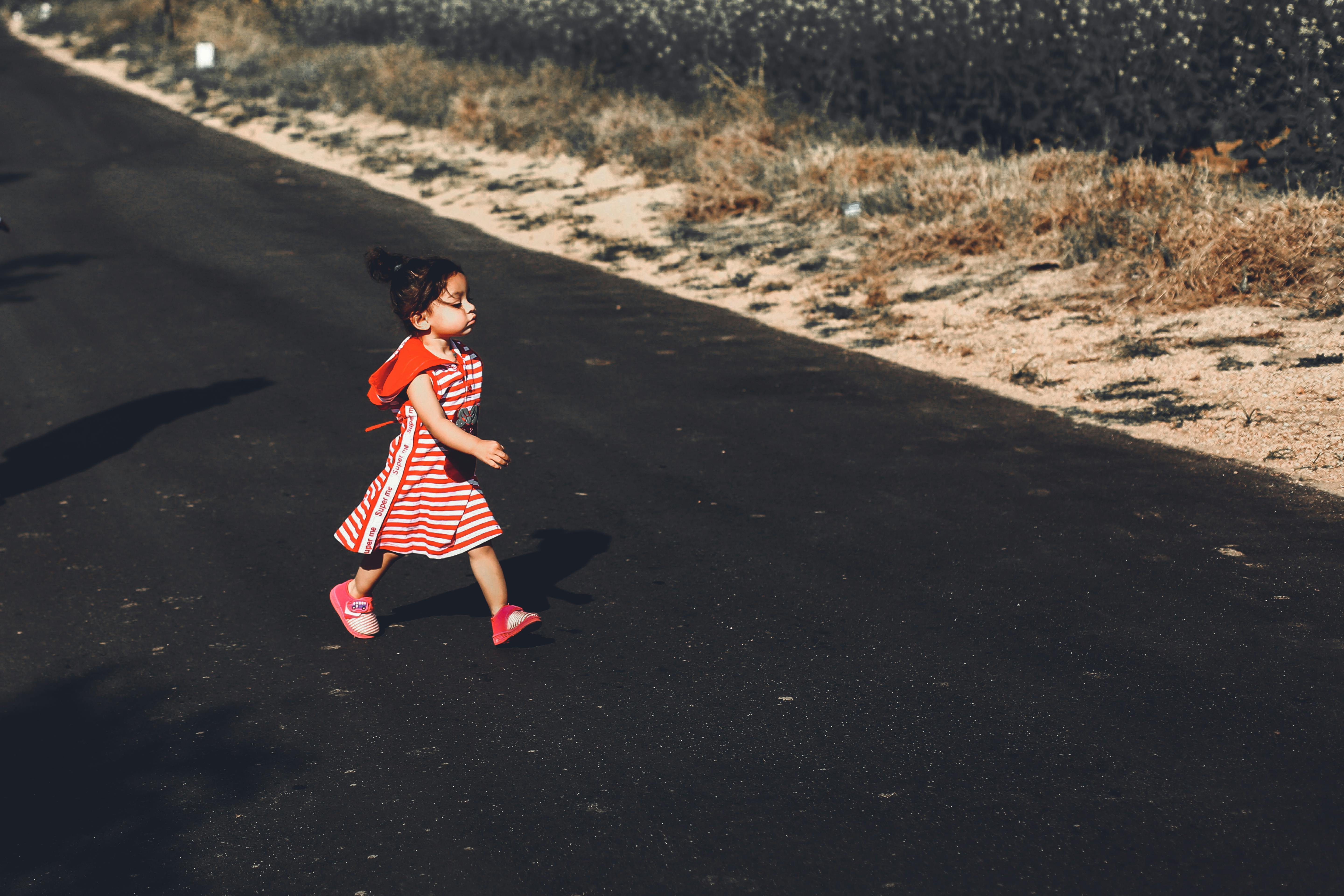 Little Girl in Dress Walking Across Ledge · Free Stock Photo