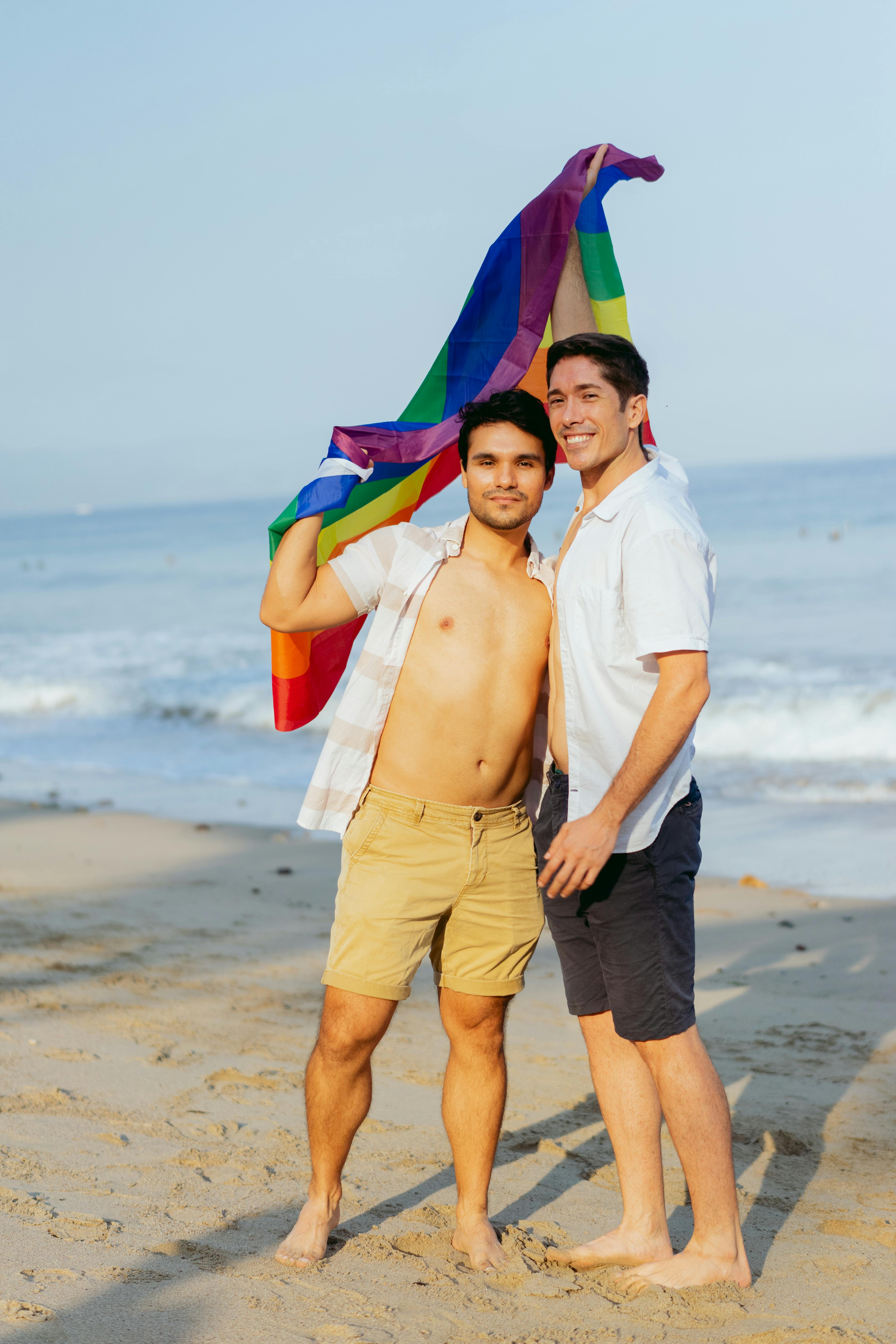 A Couple Holding a Rainbow Flag · Free Stock Photo