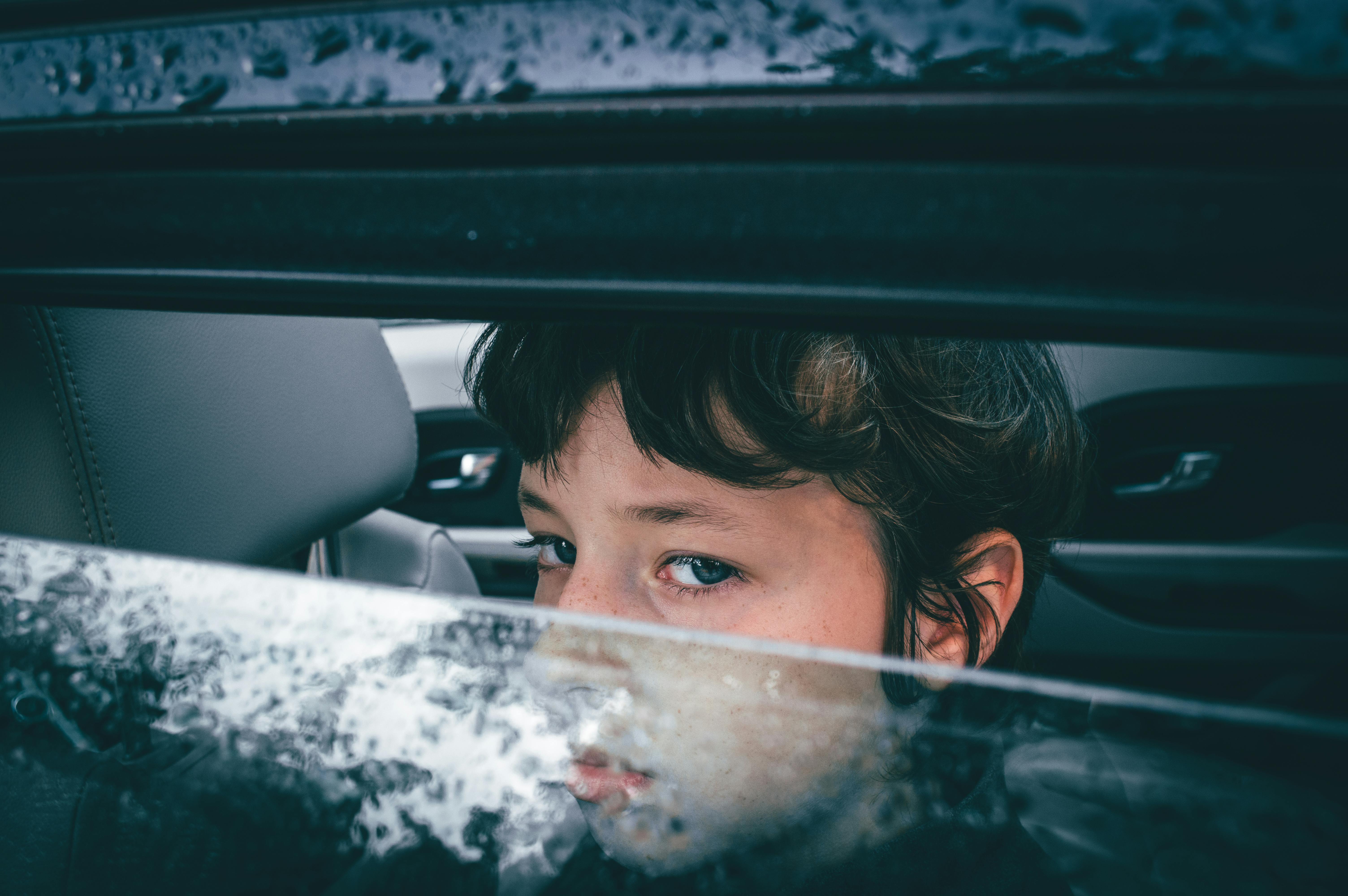 Close Up Shot of a Girl Looking at the Car Window · Free Stock Photo