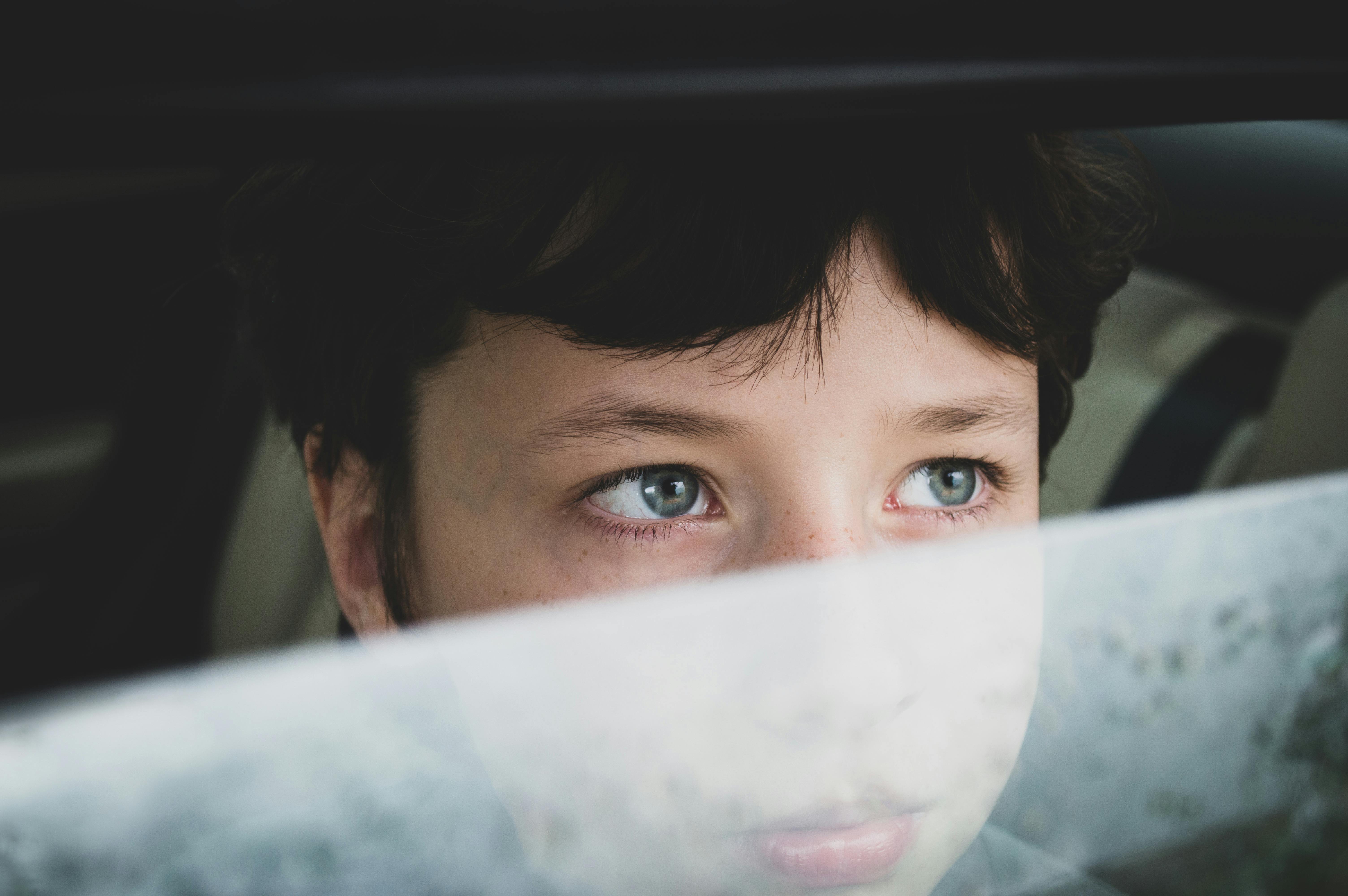 Young Boy Behind Car Window · Free Stock Photo