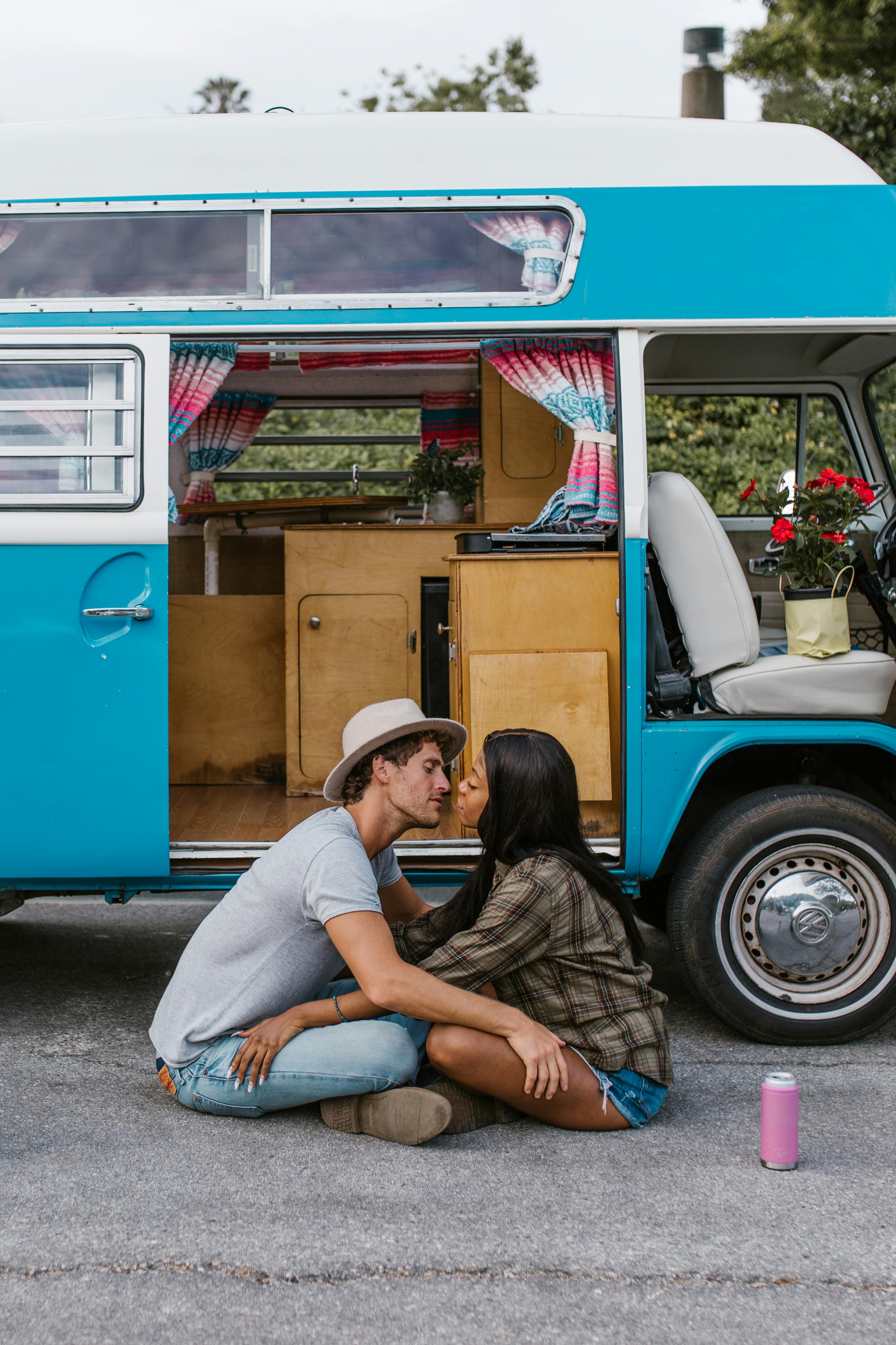 A Couple Sitting Beside a Van · Free Stock Photo