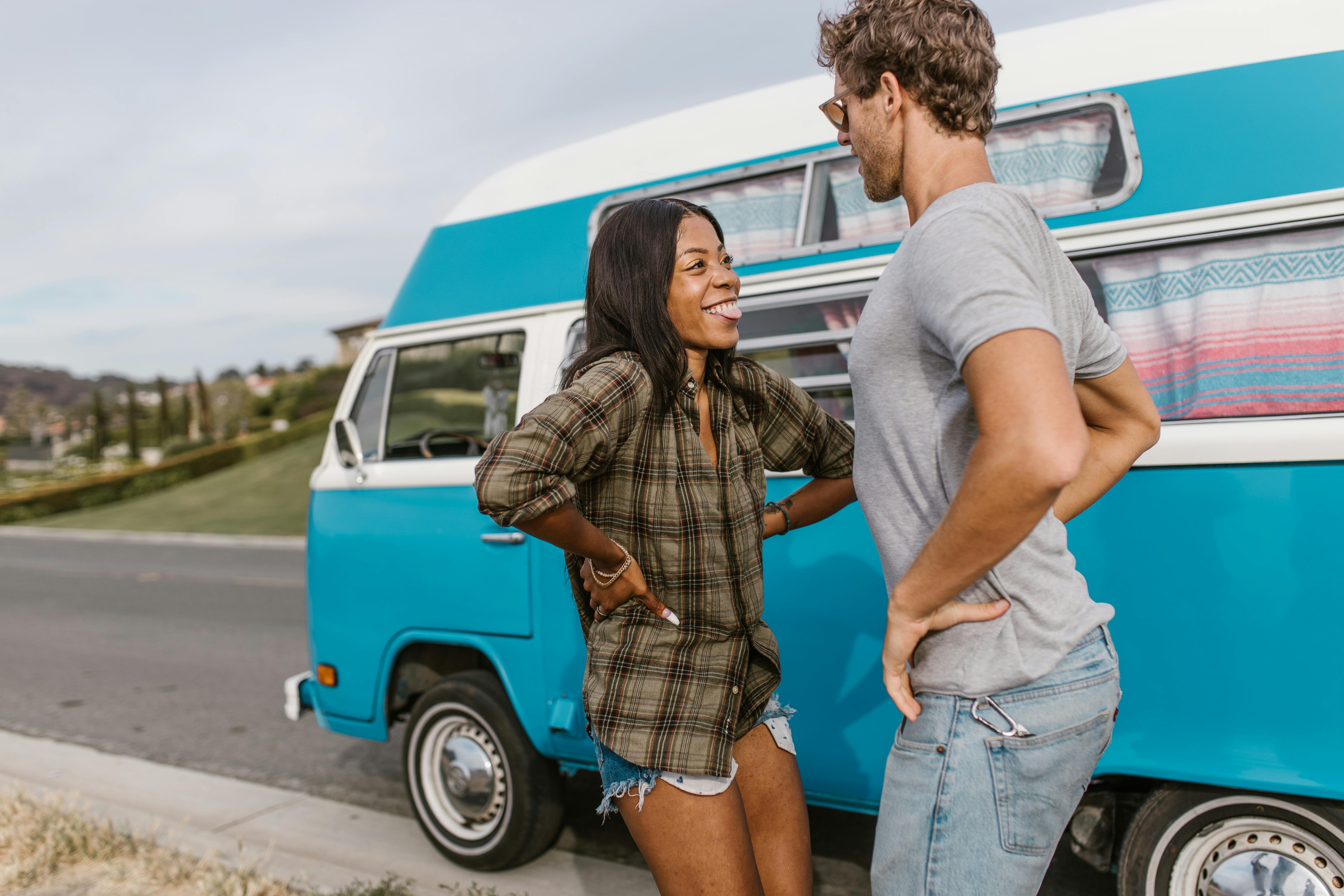 A Couple Partying next to a Campervan · Free Stock Photo