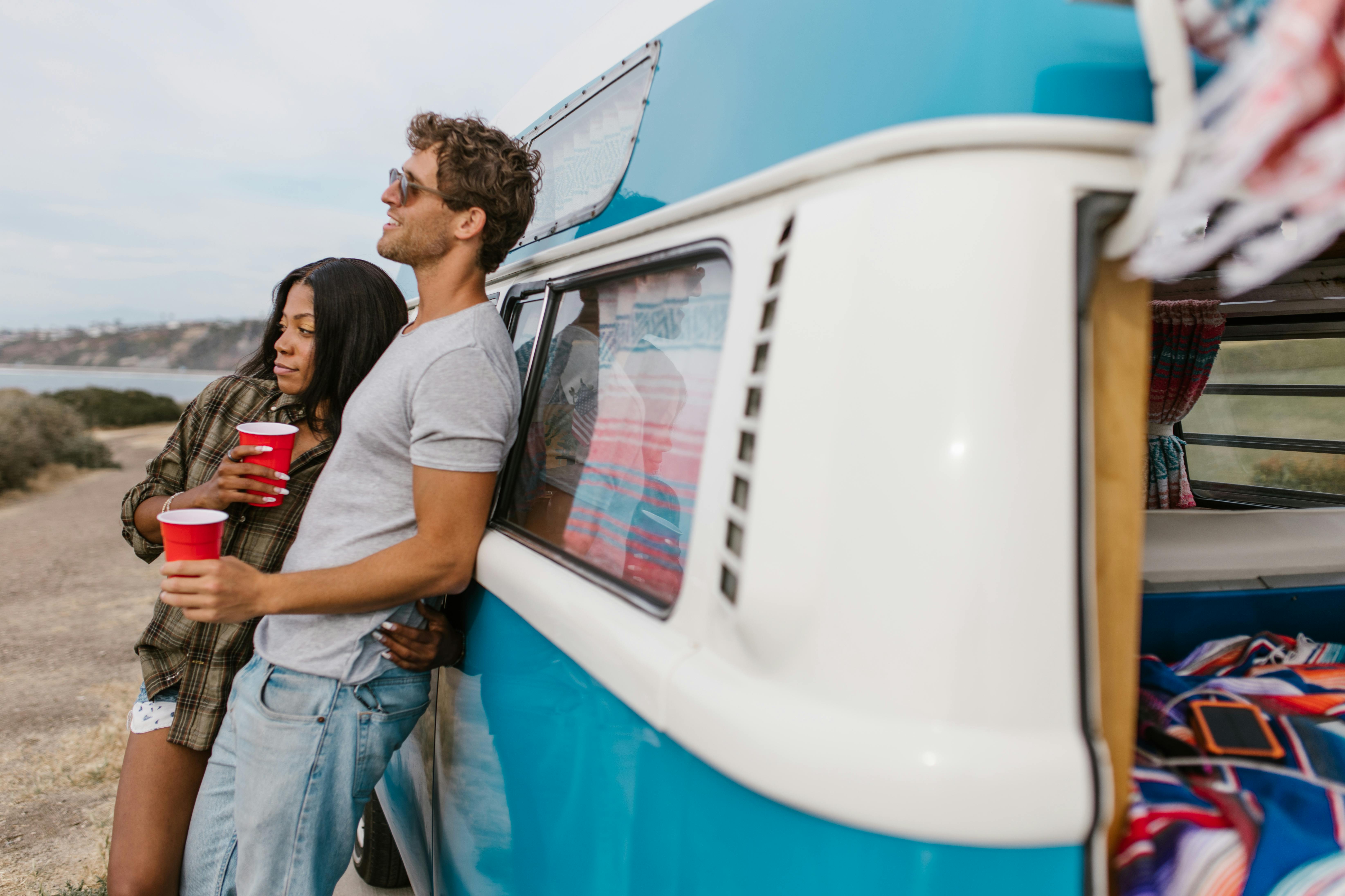 Friends Hanging Out by the Side of a Camper Van · Free Stock Photo