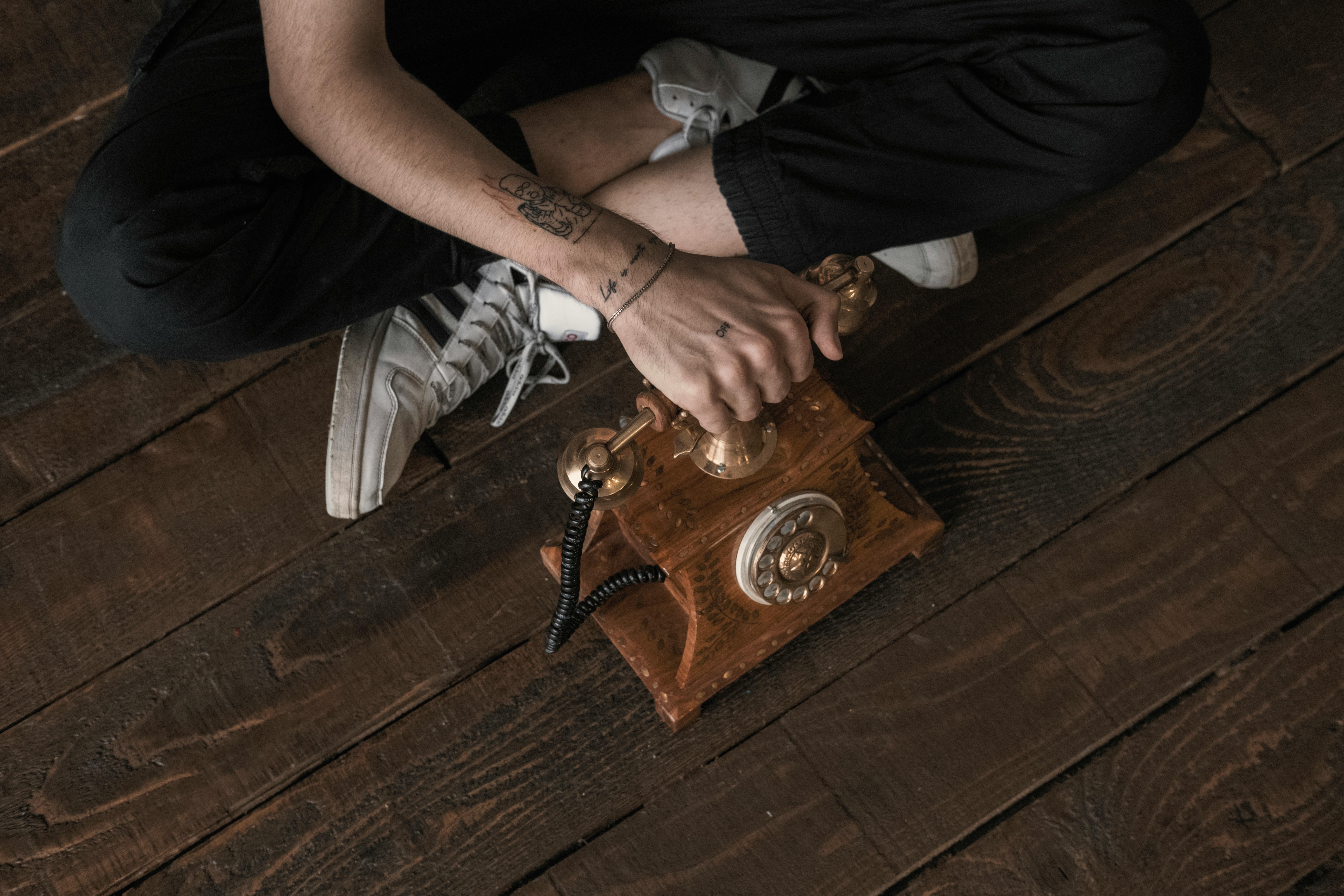 Red Rotary Telephone On Blue Sofa · Free Stock Photo