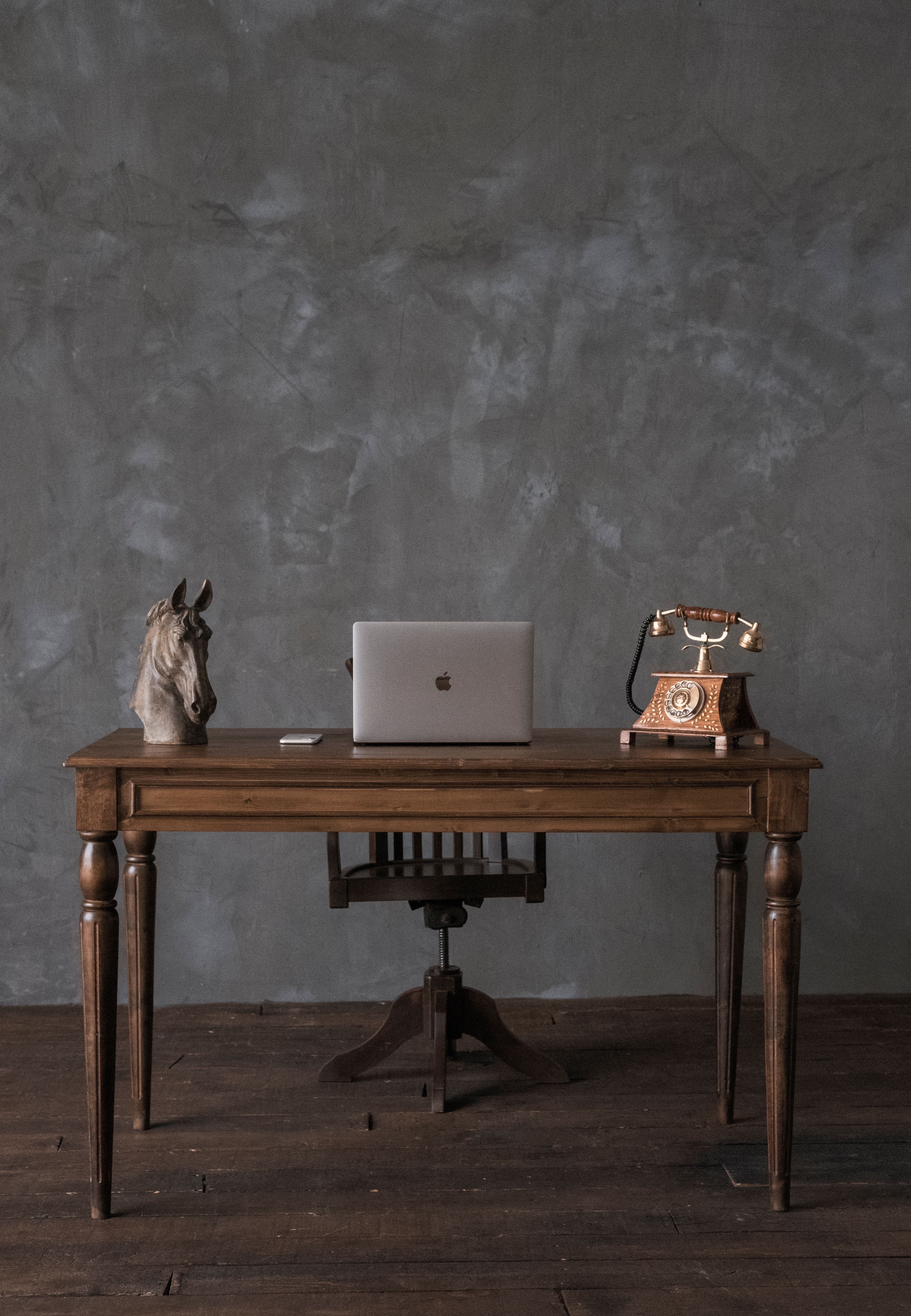 A Table with Laptop and Telephone · Free Stock Photo