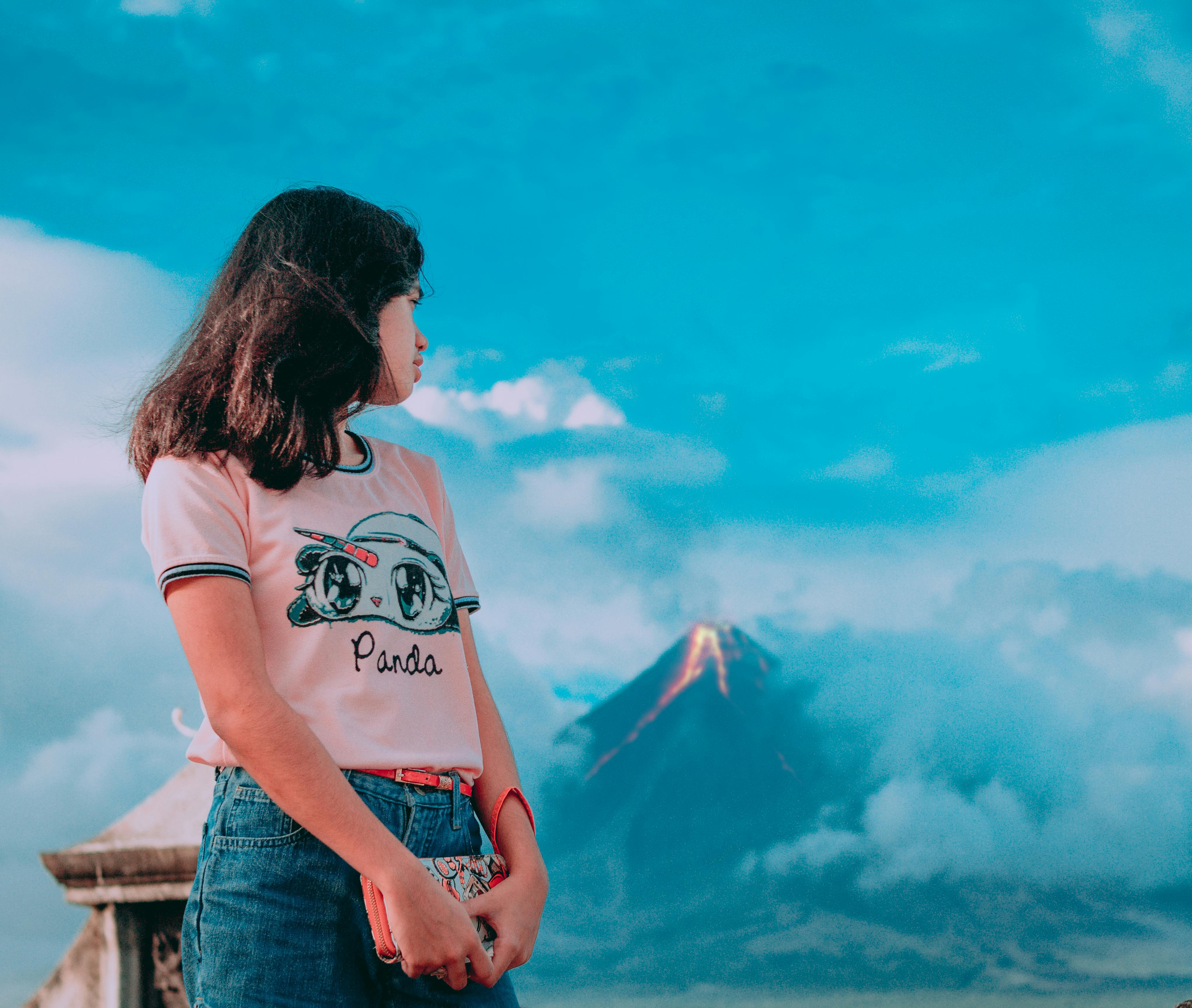 Photography of a Girl In Front of Erupting Volcano · Free Stock Photo