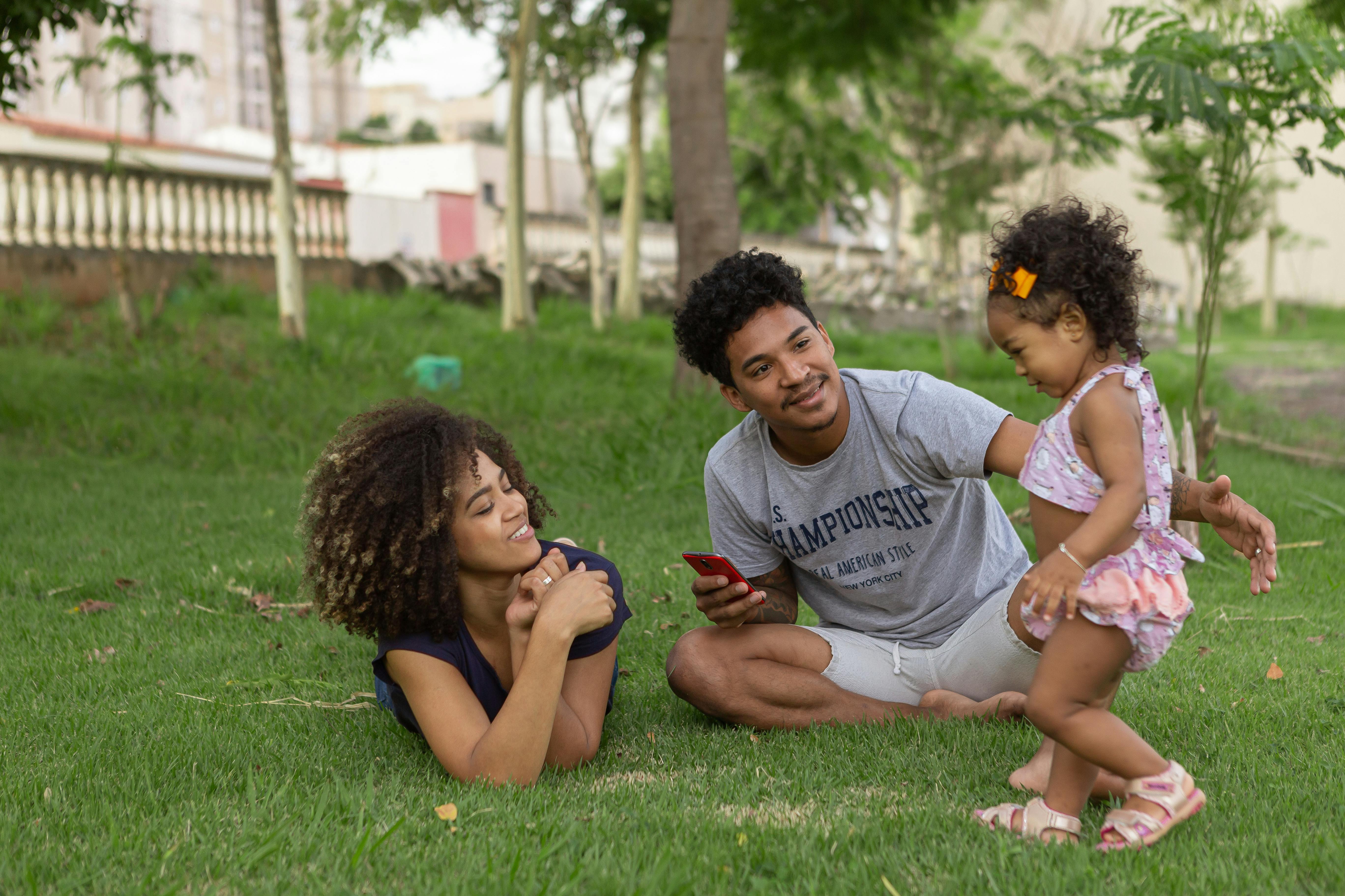 Parents Guiding Their Child To Walk · Free Stock Photo