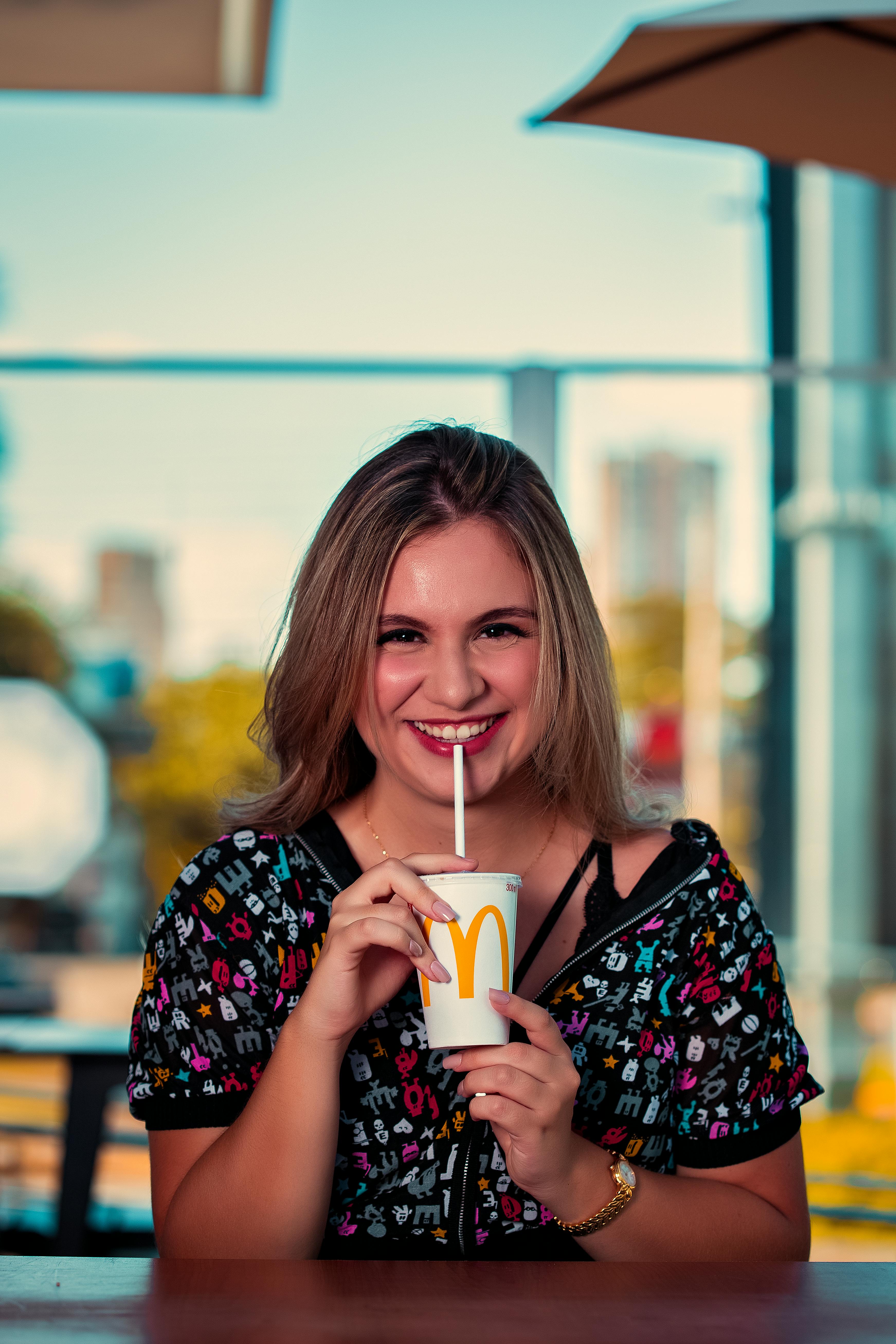 Woman sipping Beverage from a Straw · Free Stock Photo