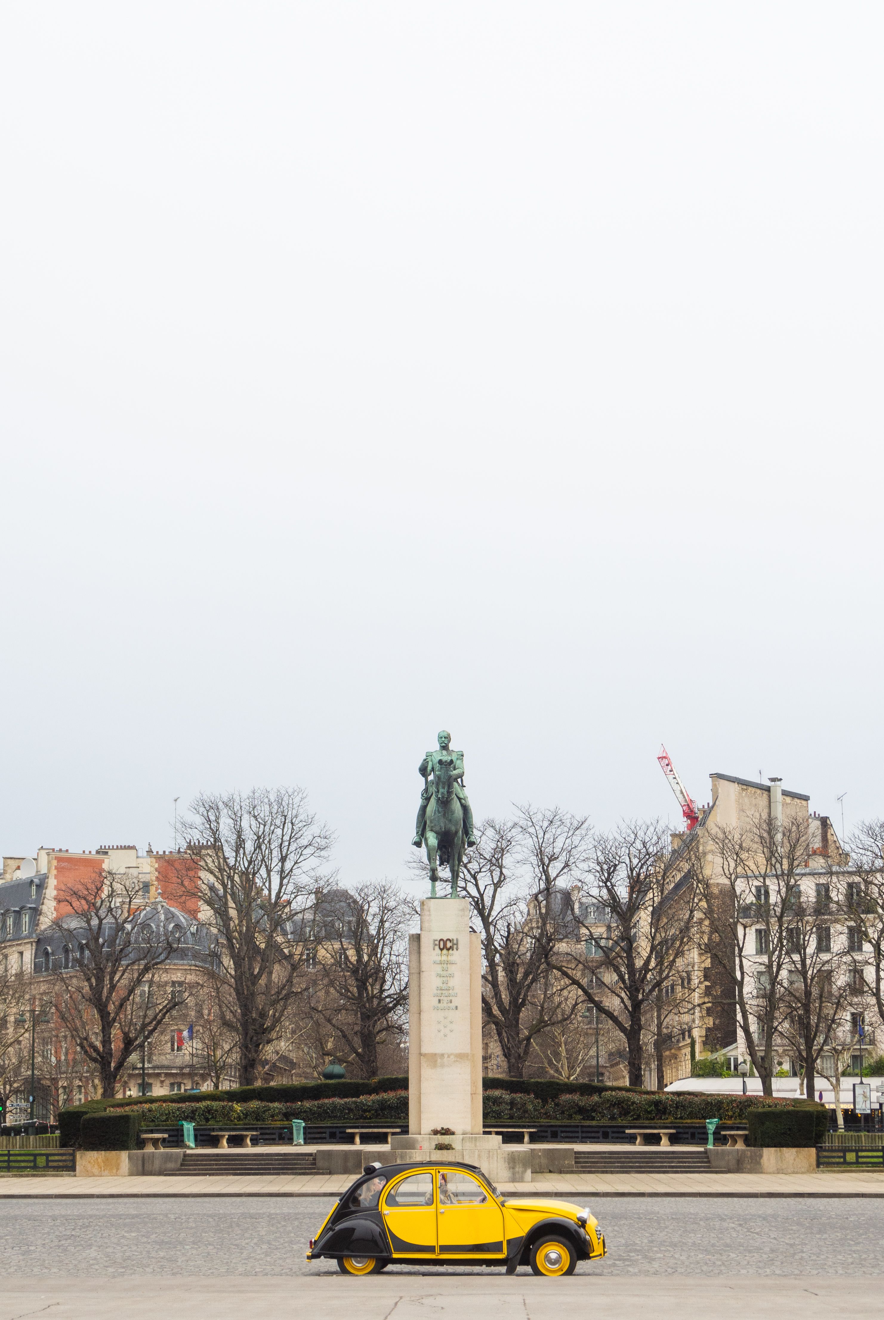 Yellow Car Parked Near a Statue on the Park · Free Stock Photo