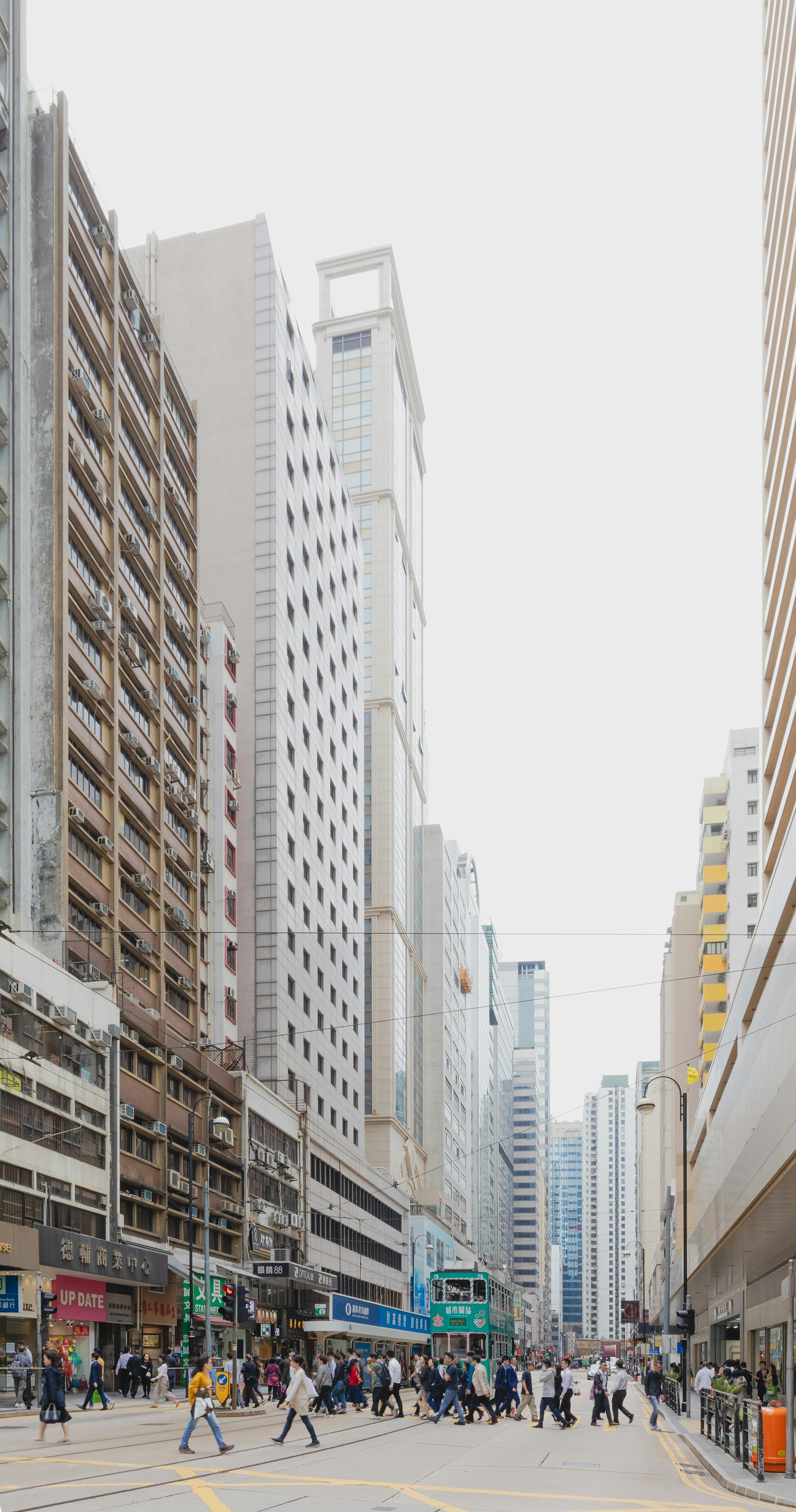 People Walking on the Street Between Buildings · Free Stock Photo