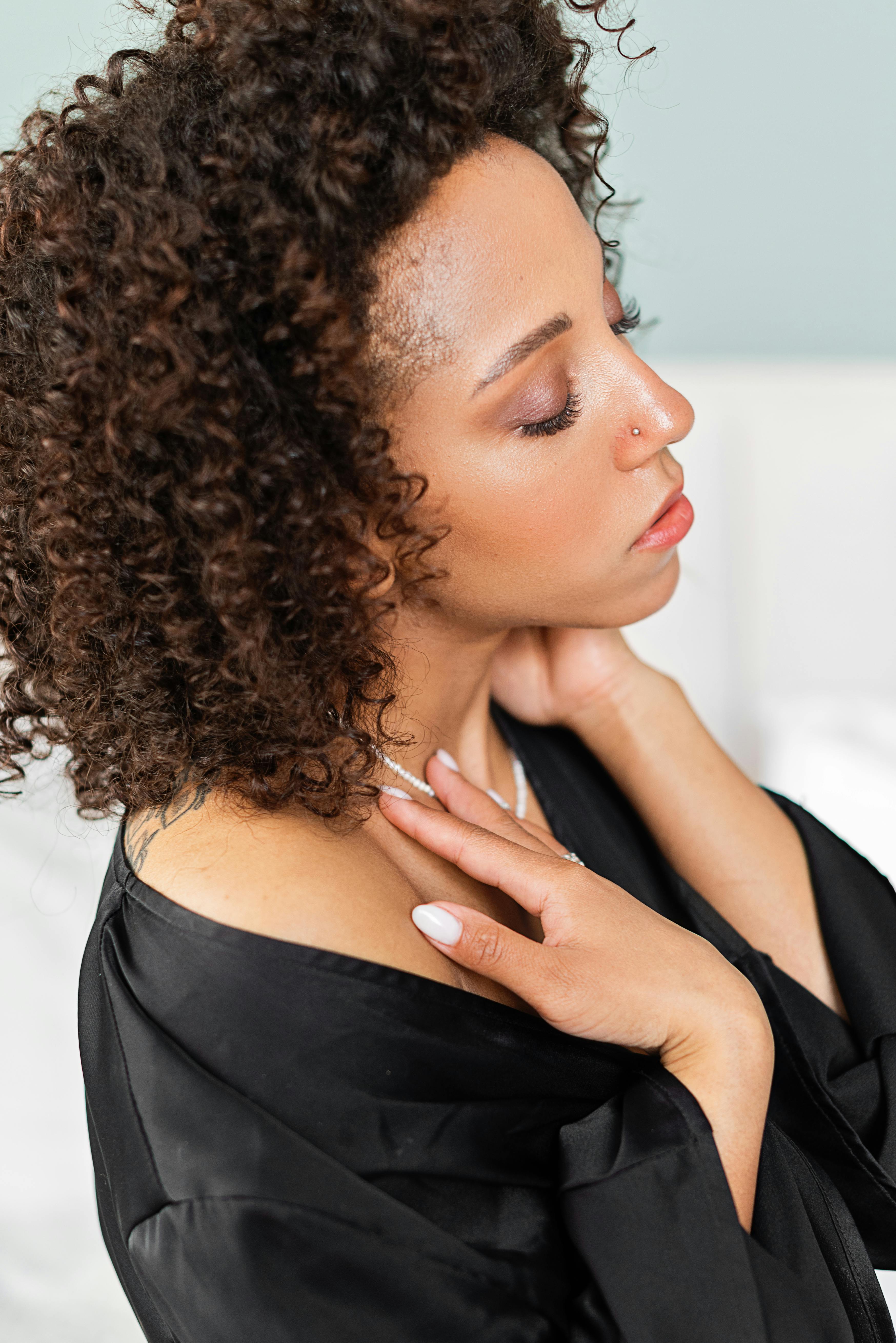 Close-Up Shot of a Curly-Haired Woman · Free Stock Photo