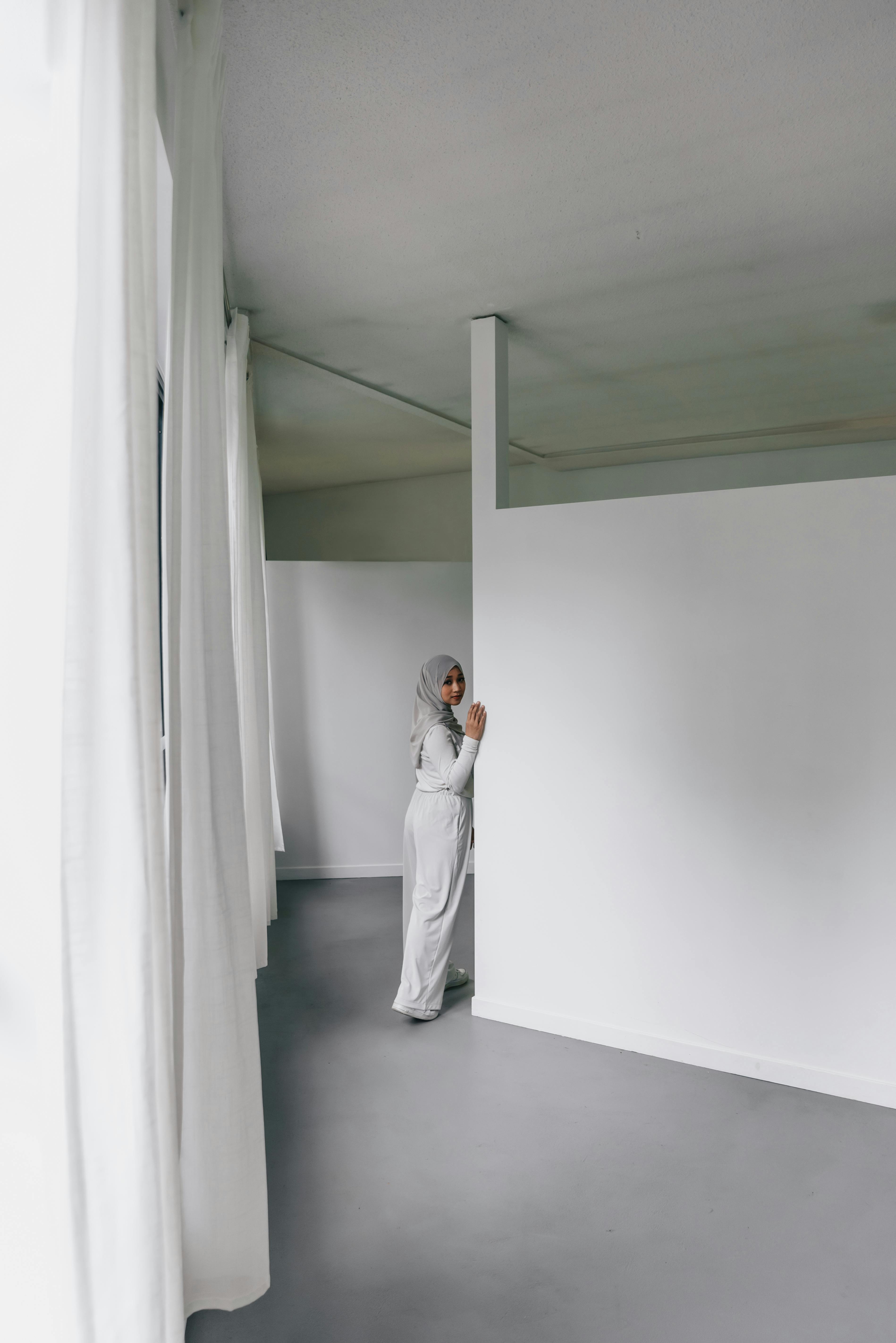 Woman Standing in Room Filled with White Curtains · Free Stock Photo