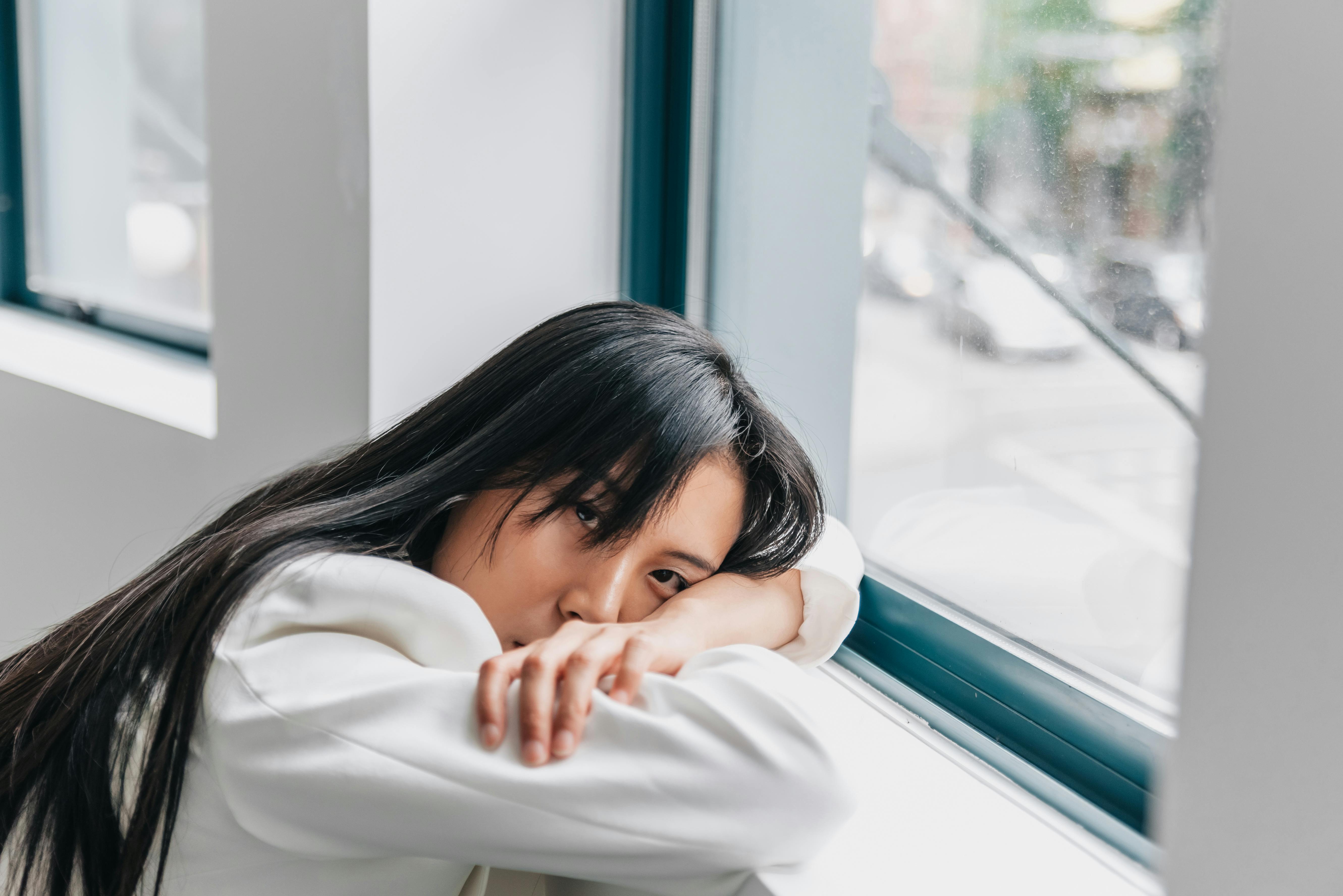 Woman Leaning on Window Sill · Free Stock Photo