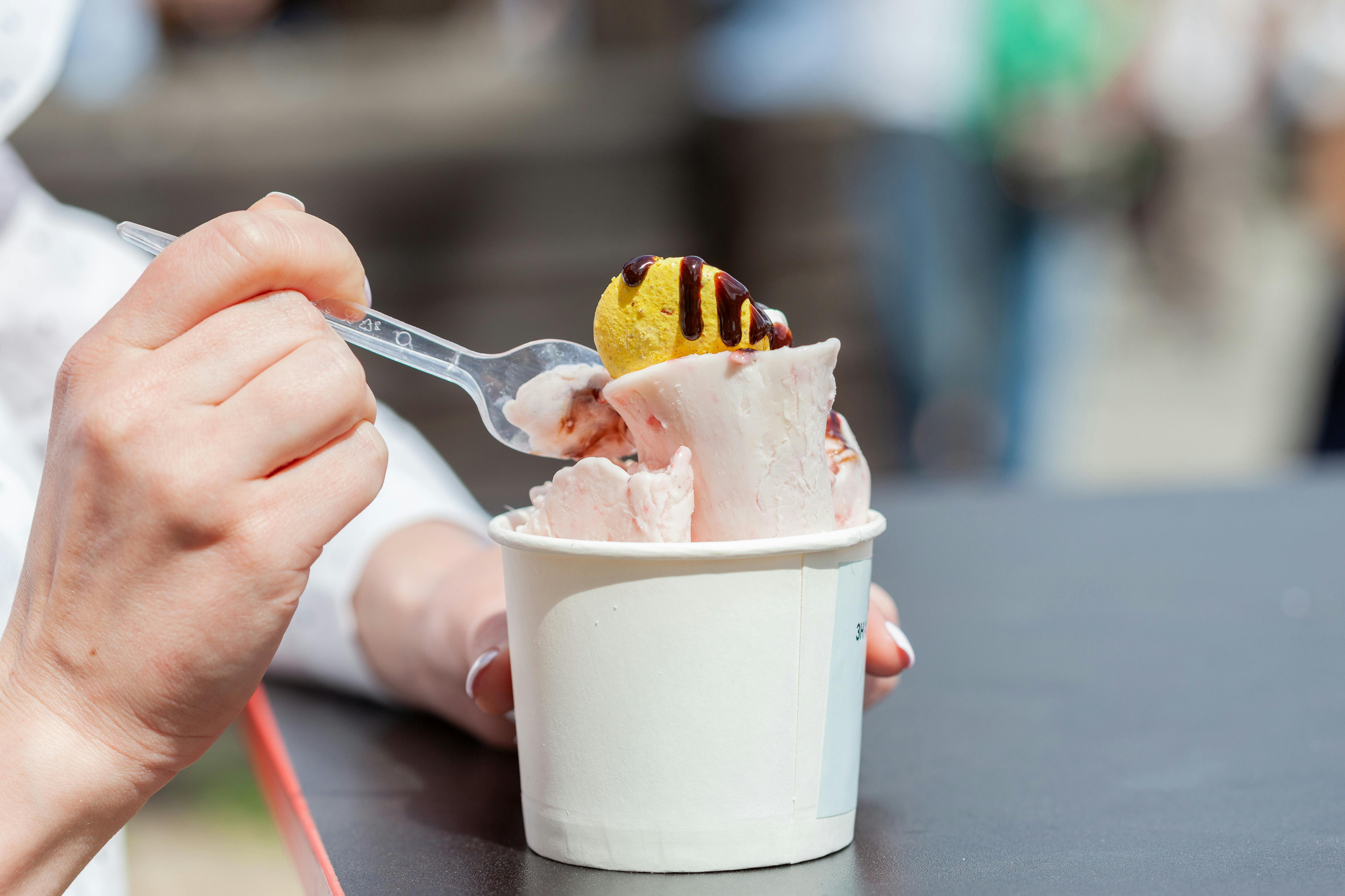 A Person Getting Ice Cream with a Spoon · Free Stock Photo