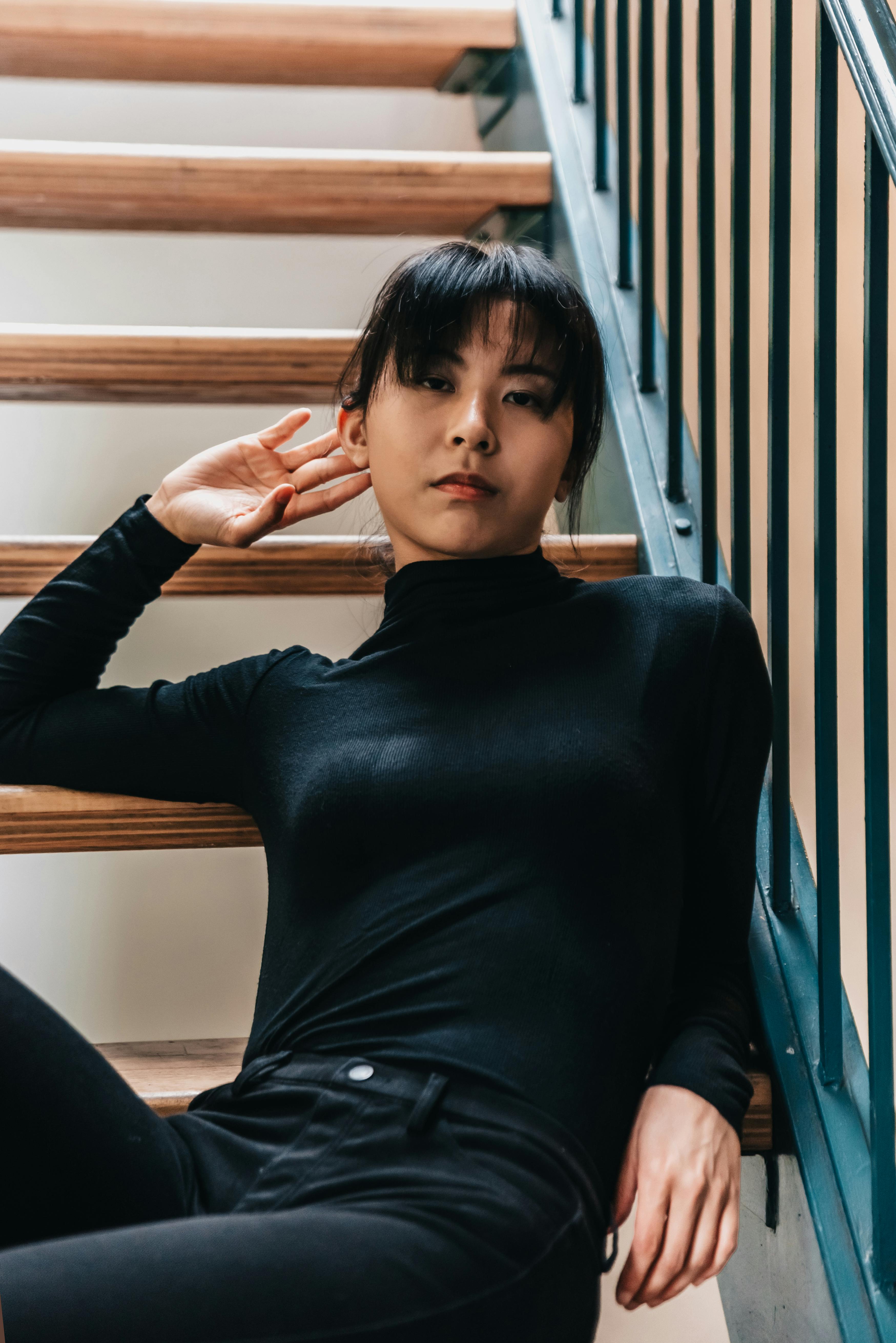 Woman in White Long Sleeves Reaching Her Back Using Her Hand · Free ...