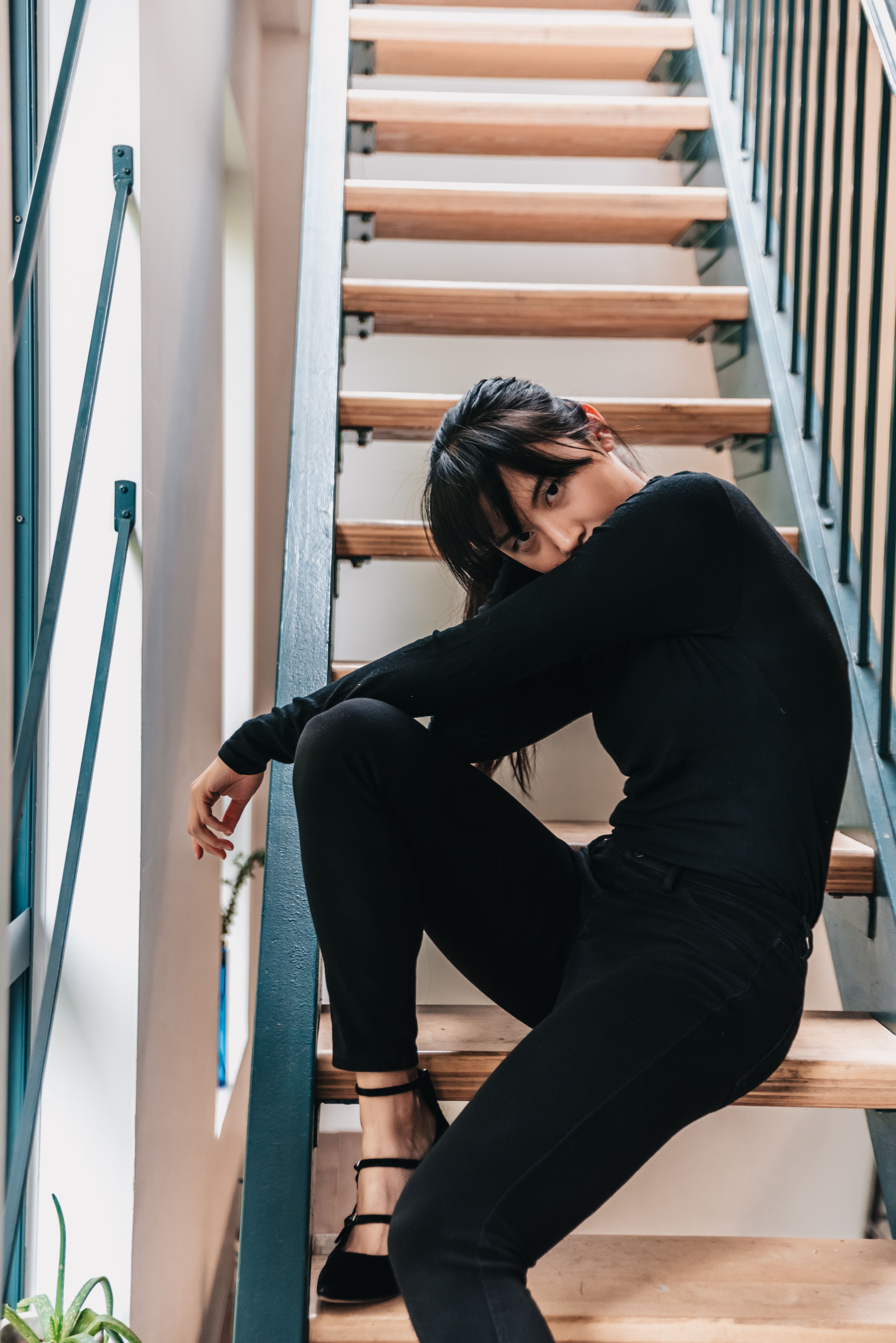 A Woman Posing wile Sitting on the Stairs · Free Stock Photo