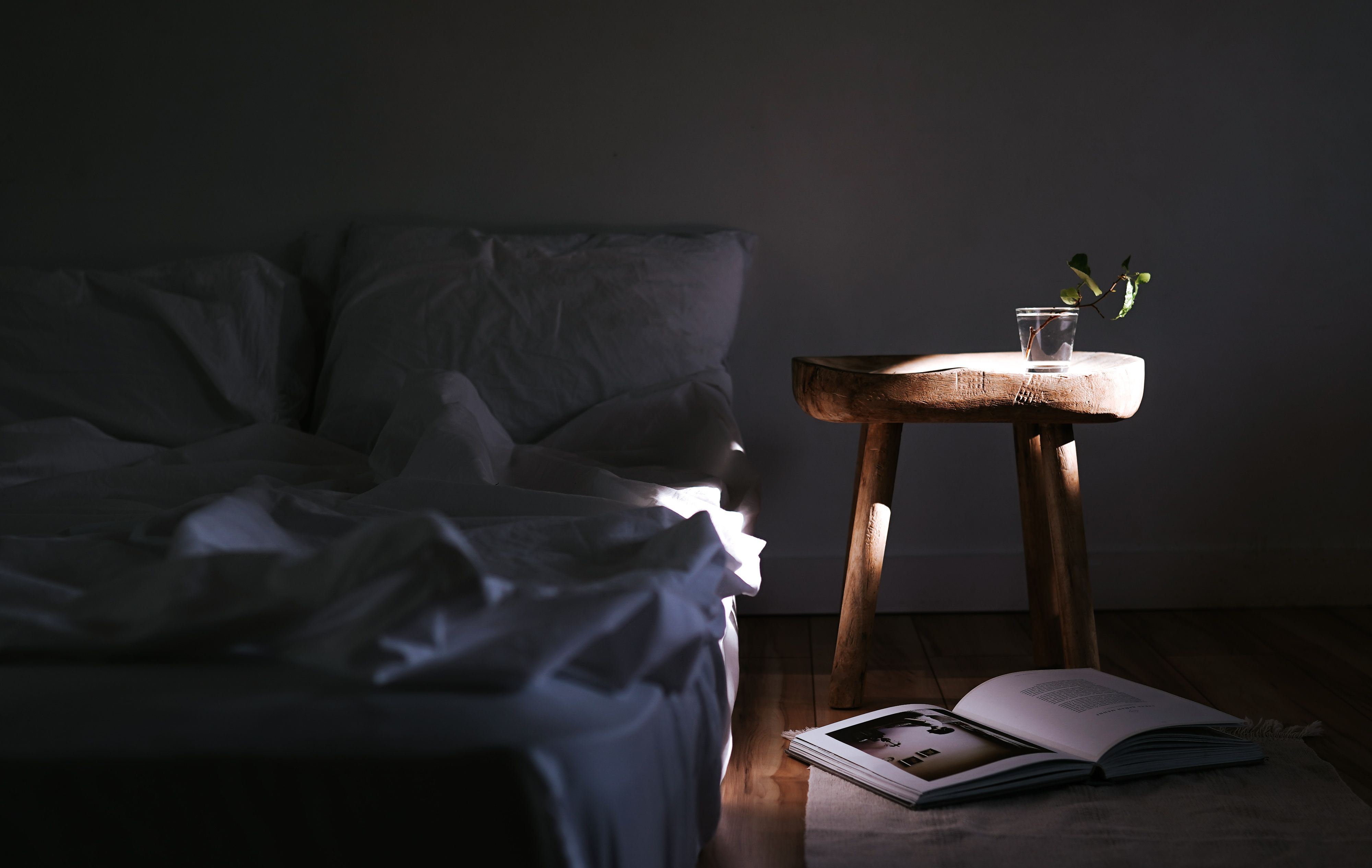 Dwarf girl sitting in bed with open laptop and smiling · Free Stock Photo