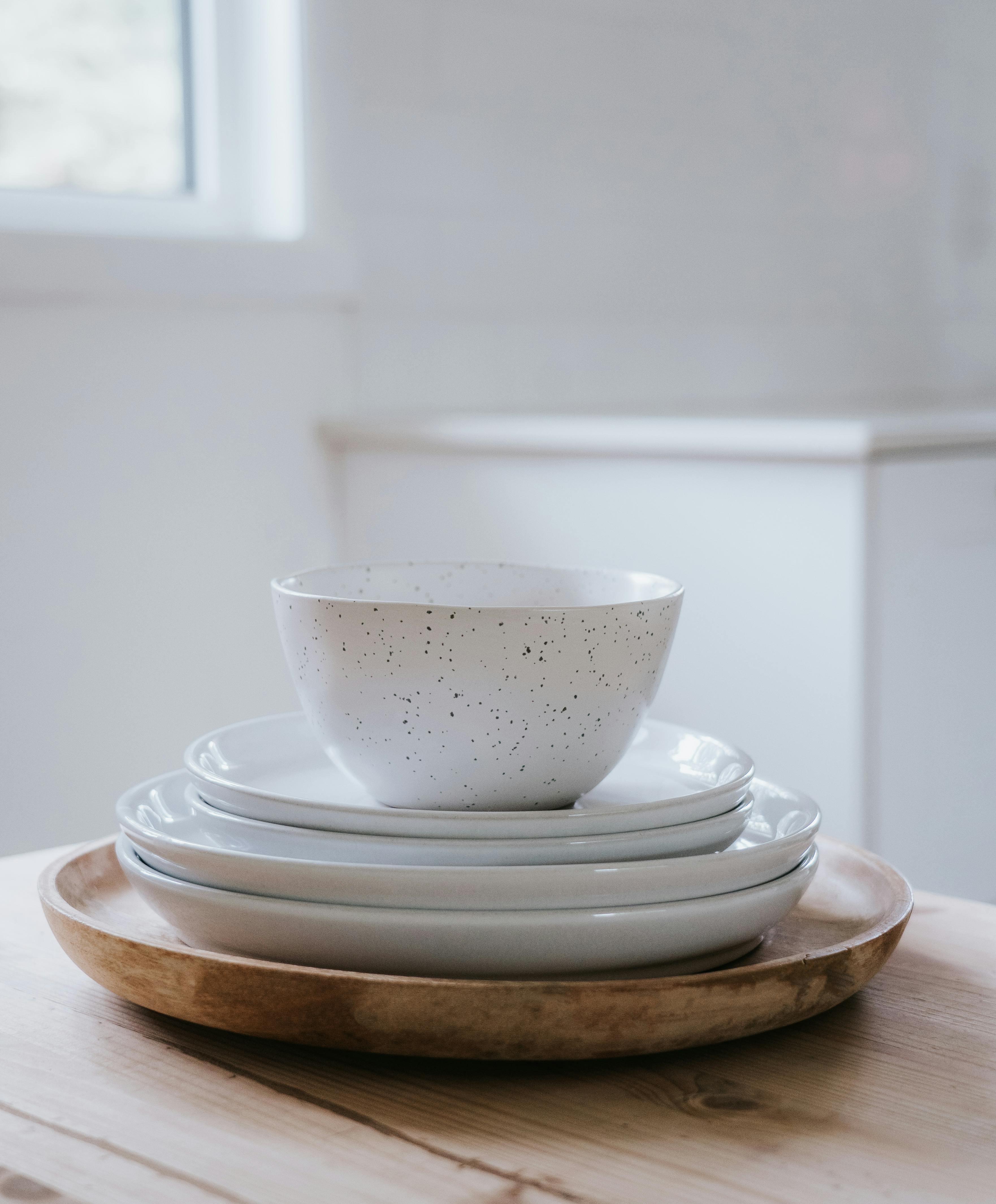 Close-Up Shot of Shards of a Broken Ceramic Plate on a Wooden Surface ...