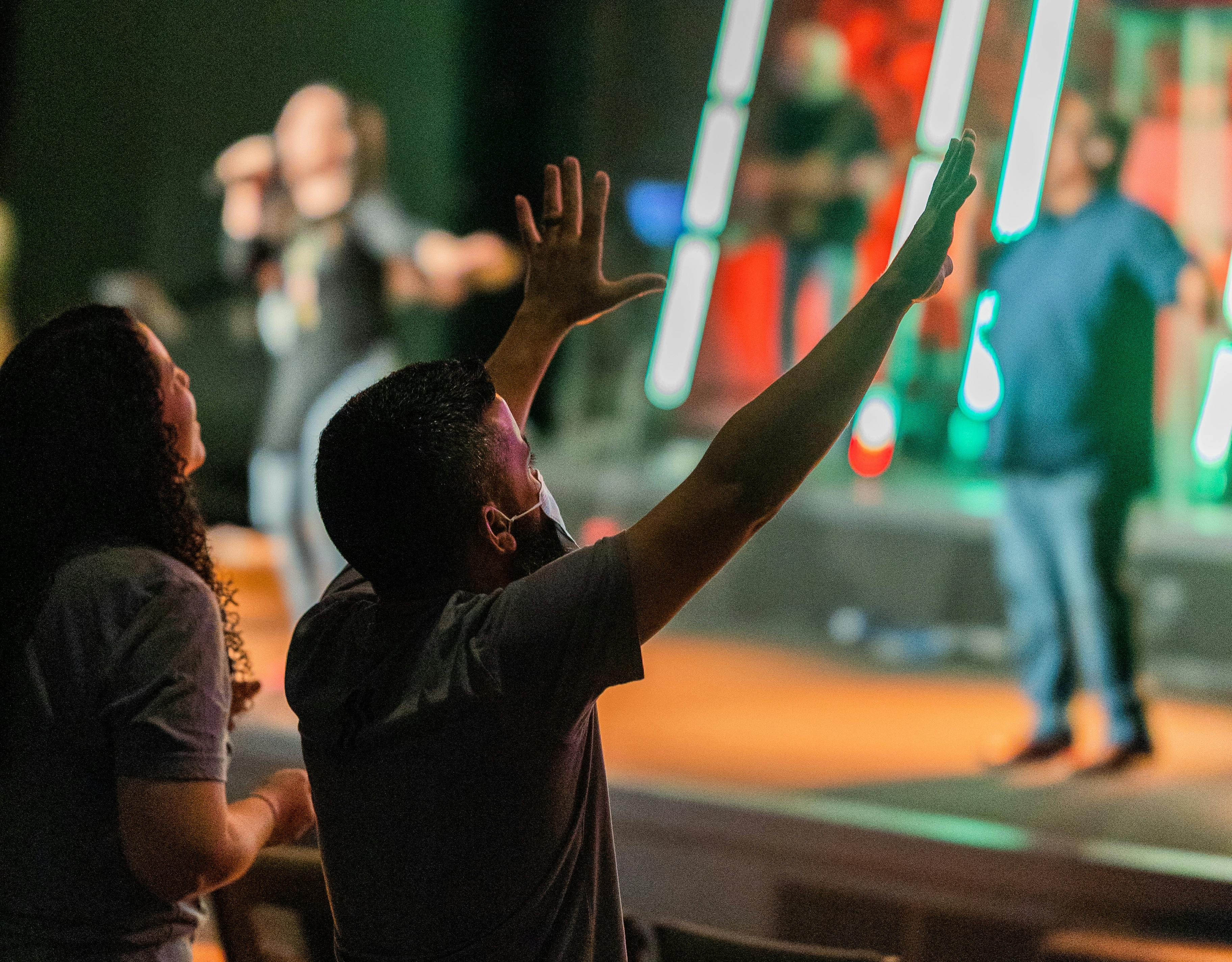 Photo of a Man in a Gray Shirt Raising His Hands · Free Stock Photo
