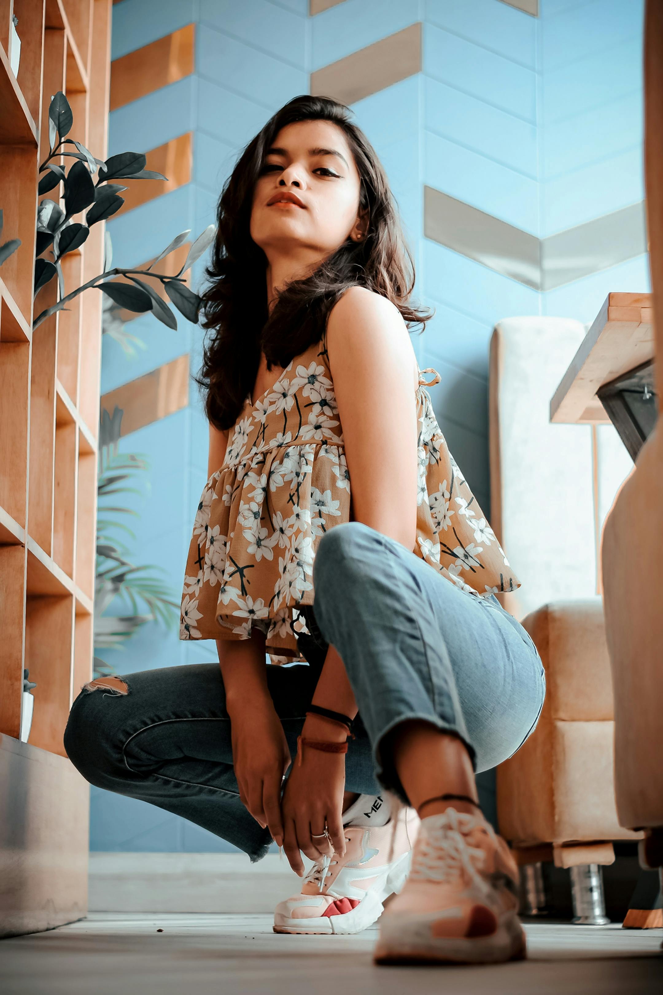 Woman in Jeans and a Blouse Crouching · Free Stock Photo