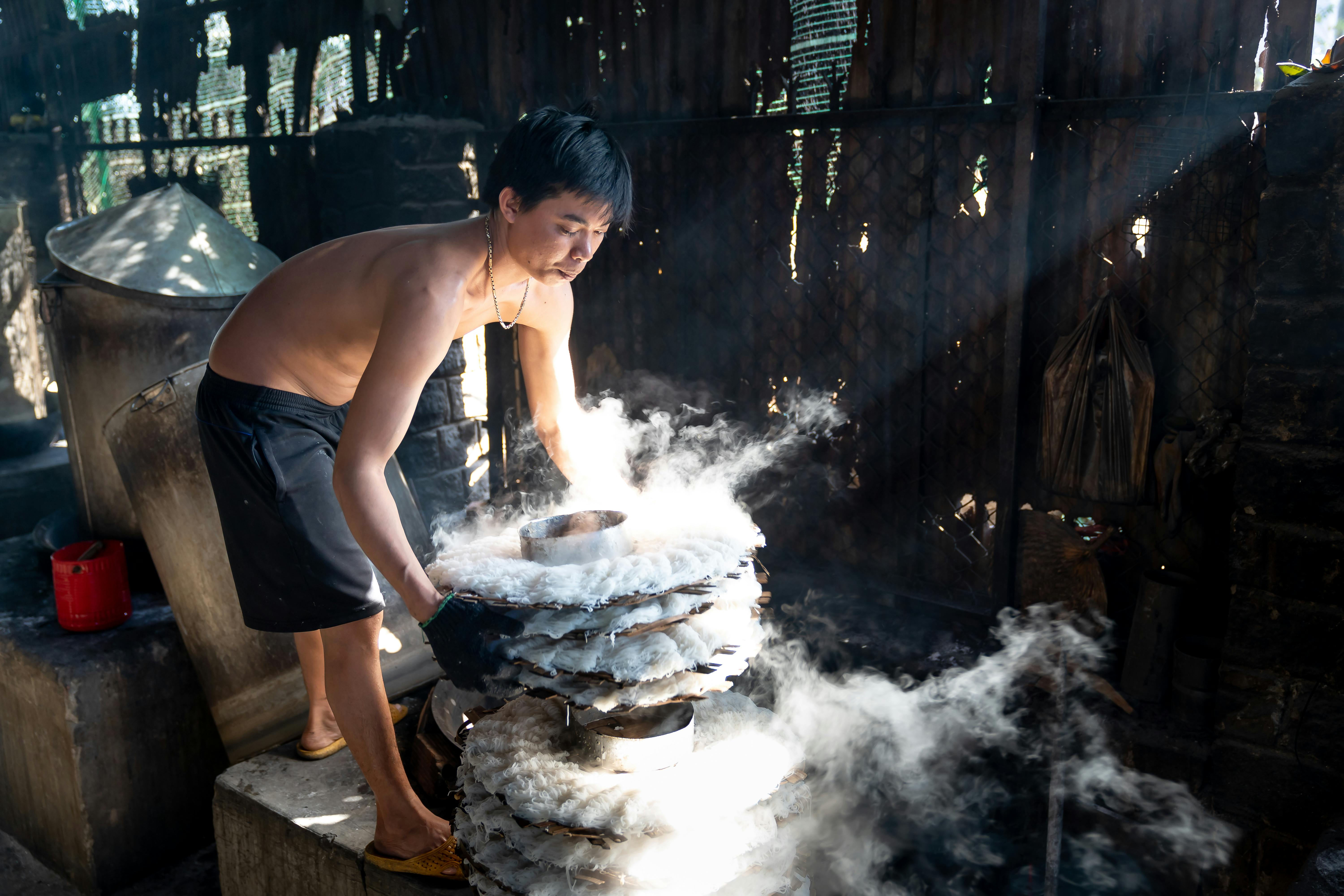 A Shirtless Man Cooking Vermicelli · Free Stock Photo