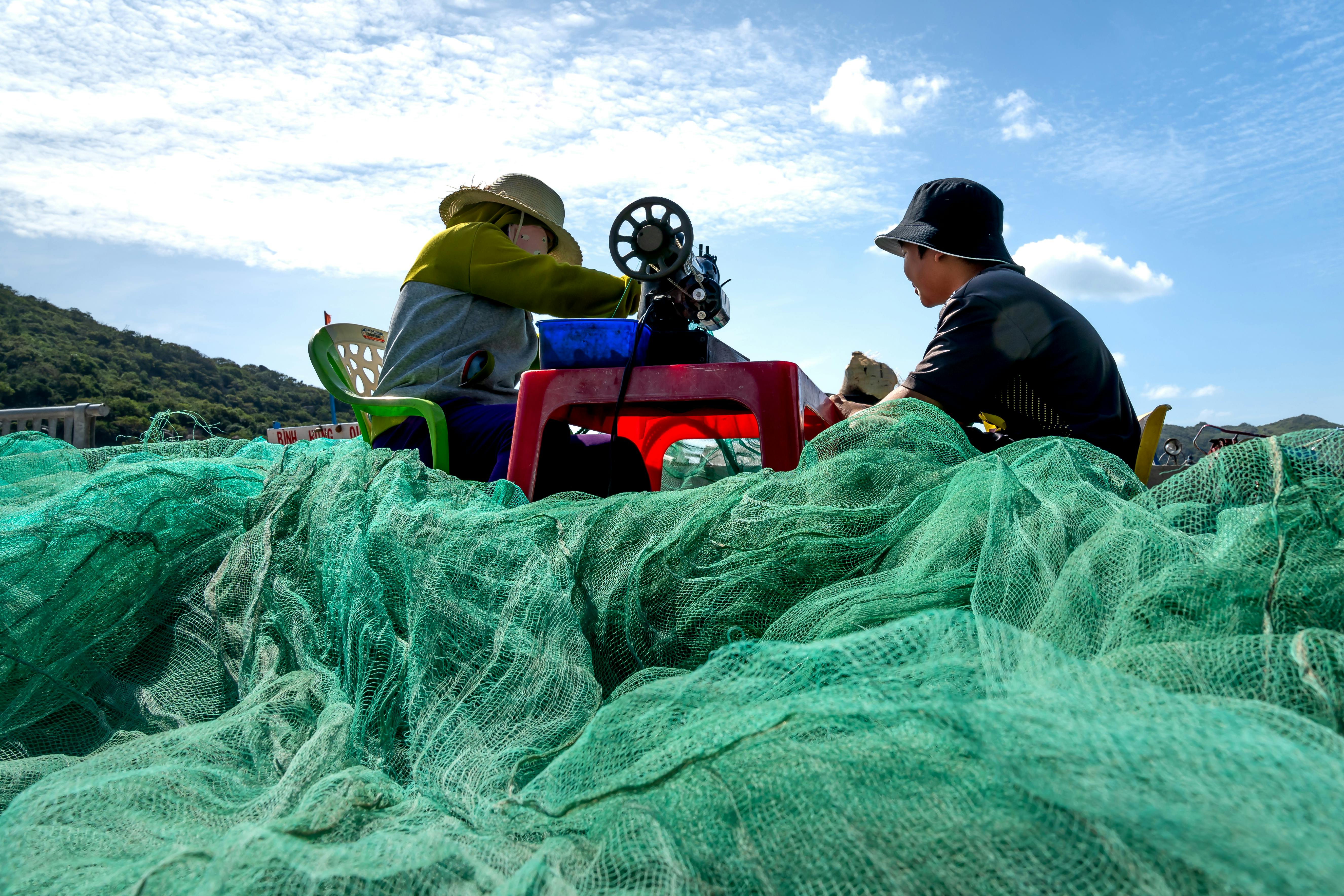 Person Sewing a Fishing Net · Free Stock Photo