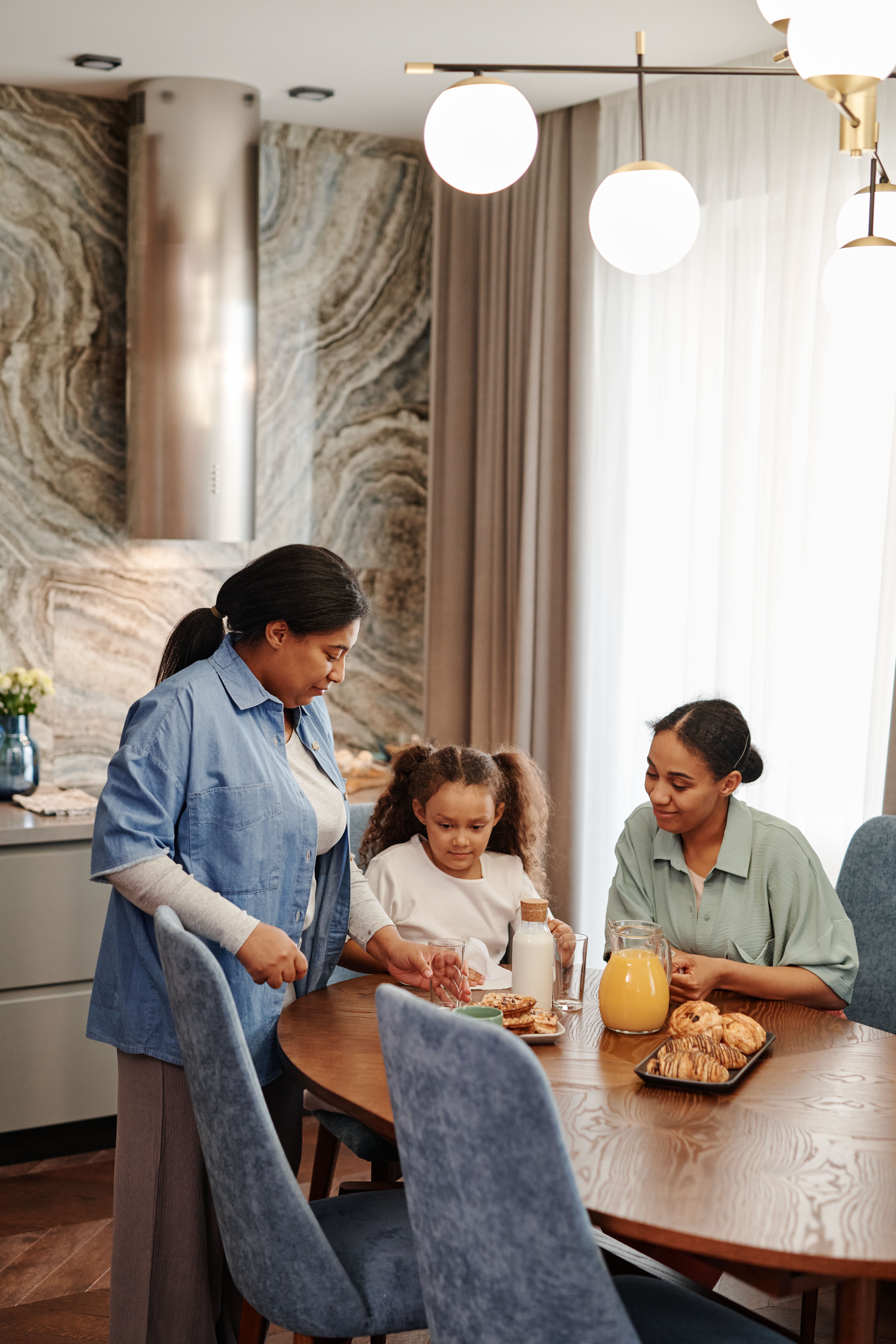 Family Setting the Table for Dinner · Free Stock Photo
