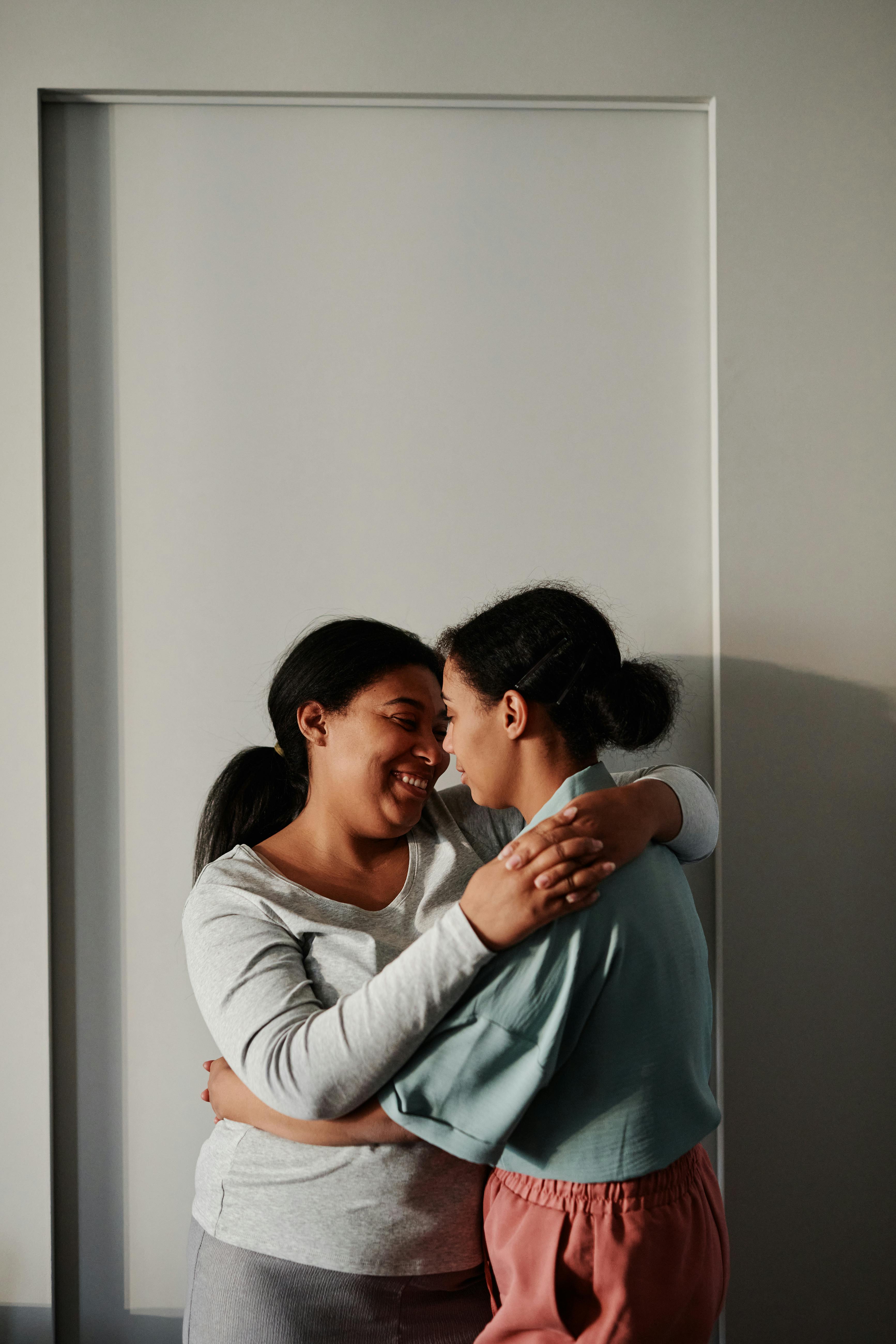 Women Hugging on White Background · Free Stock Photo