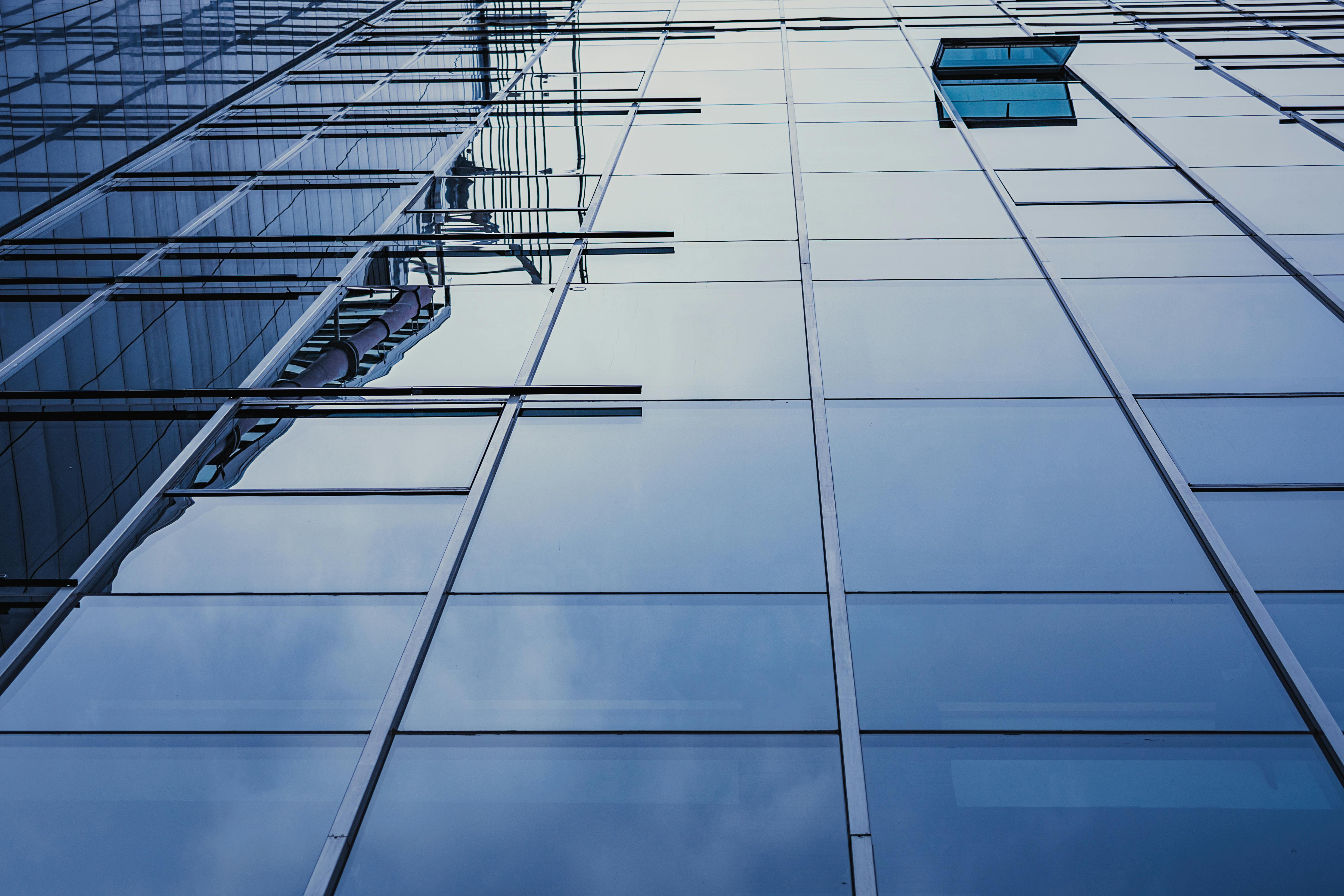 Low-Angle Shot of Glass Windows of a Building · Free Stock Photo