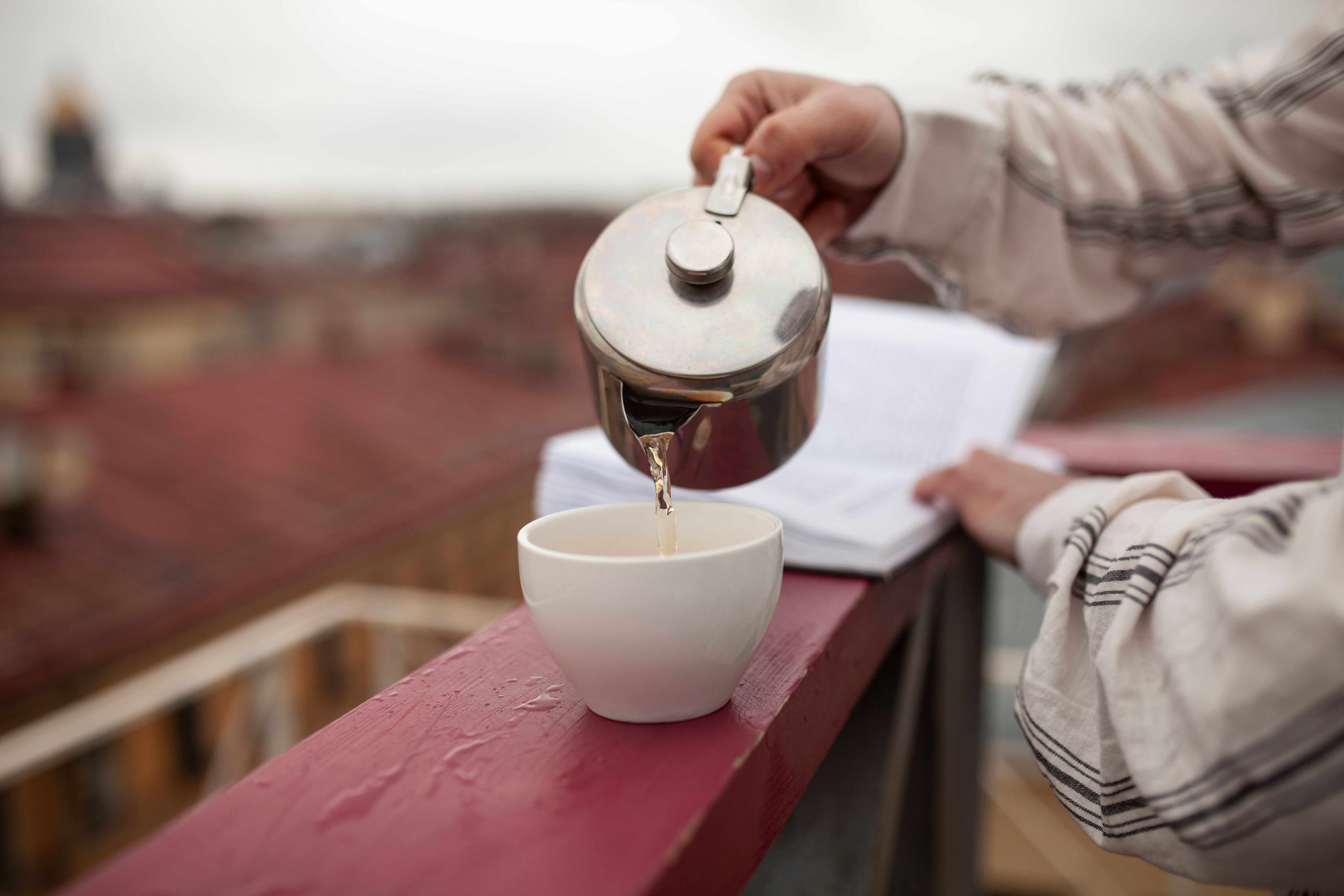 A Man Holding a Teapot · Free Stock Photo