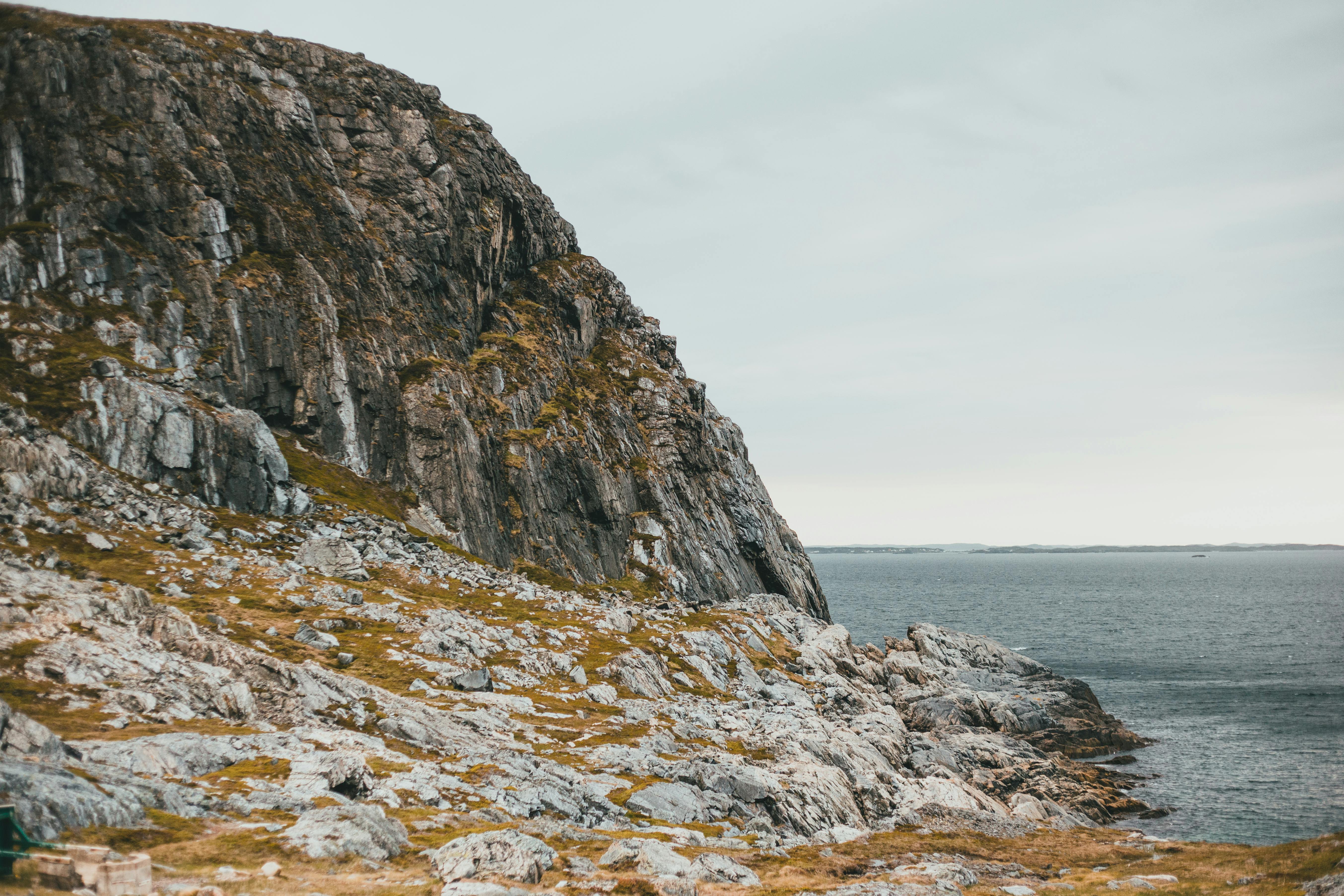 Eroded Cliff Towering over Sea · Free Stock Photo