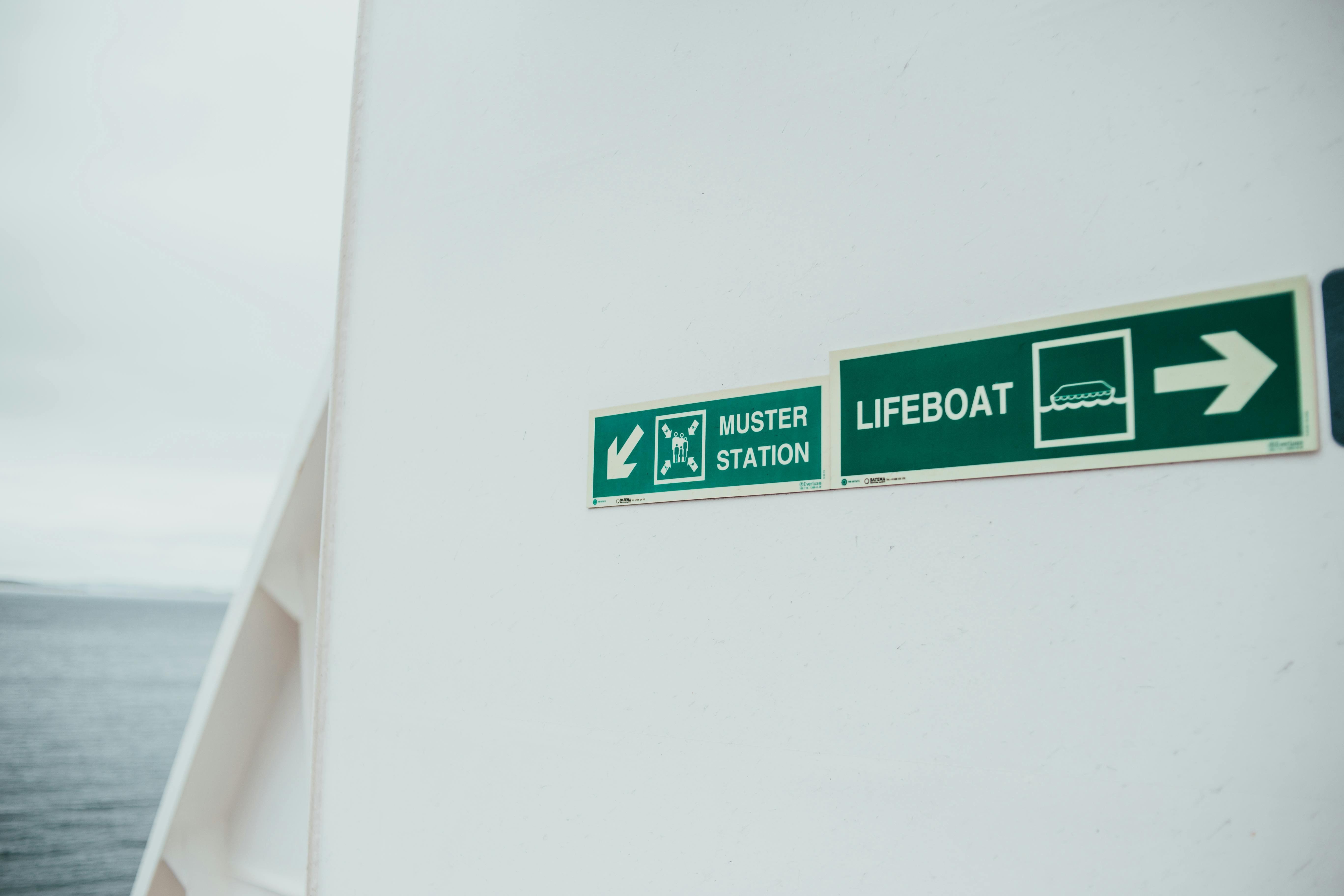 Muster Station and Lifeboat Information Signs · Free Stock Photo