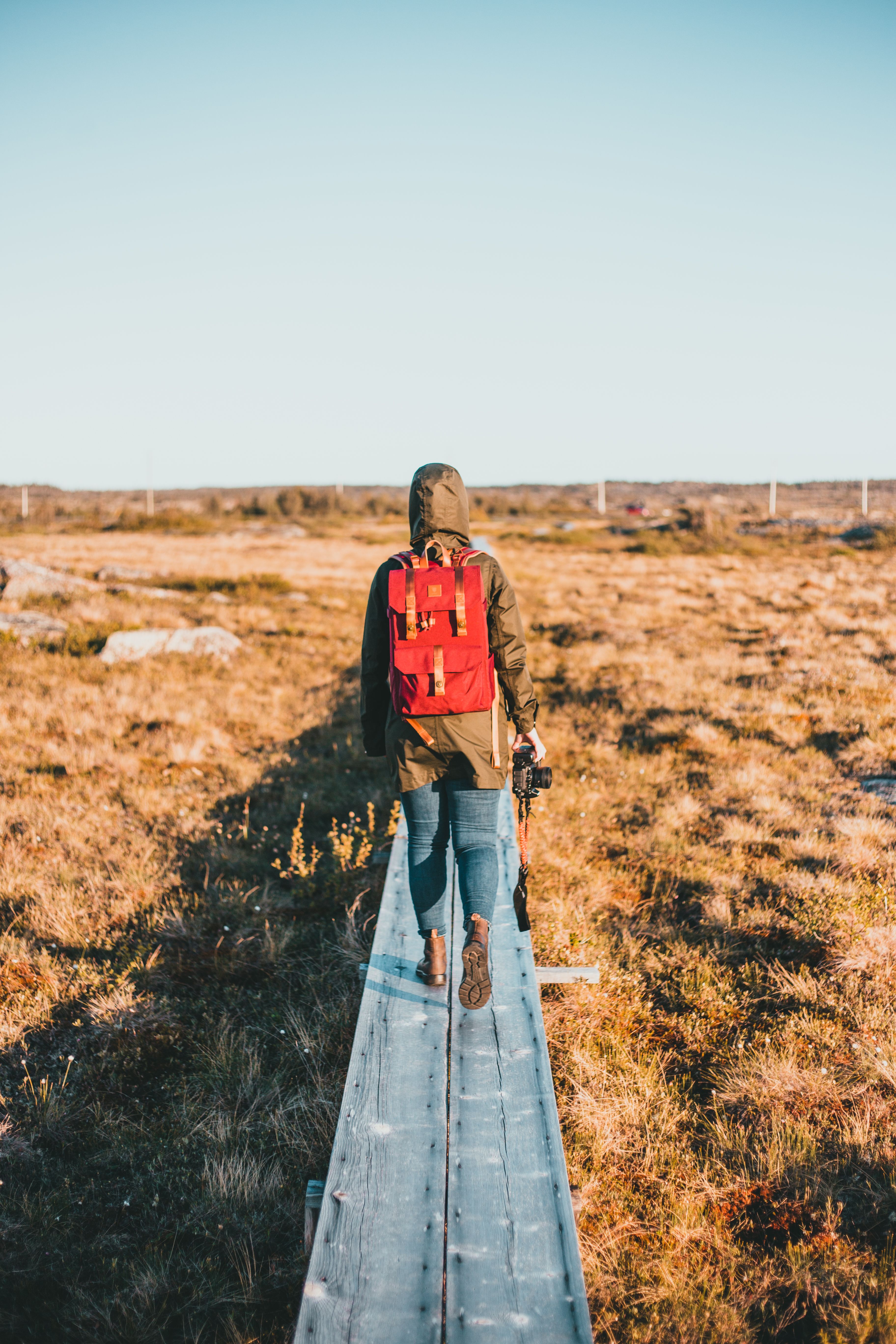 Person with Backpack Walking on Footpath · Free Stock Photo