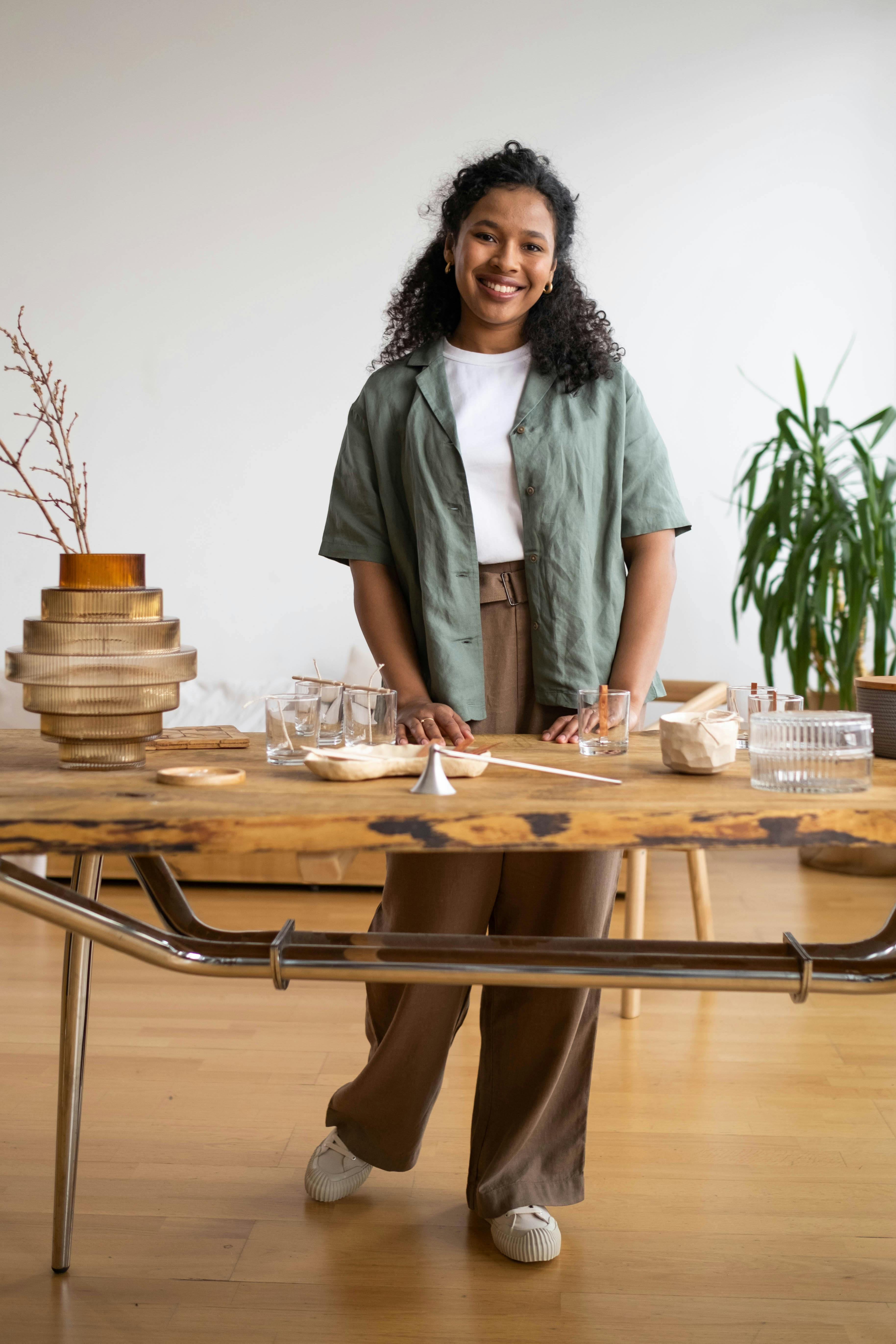 Woman Standing Near Wooden Table · Free Stock Photo