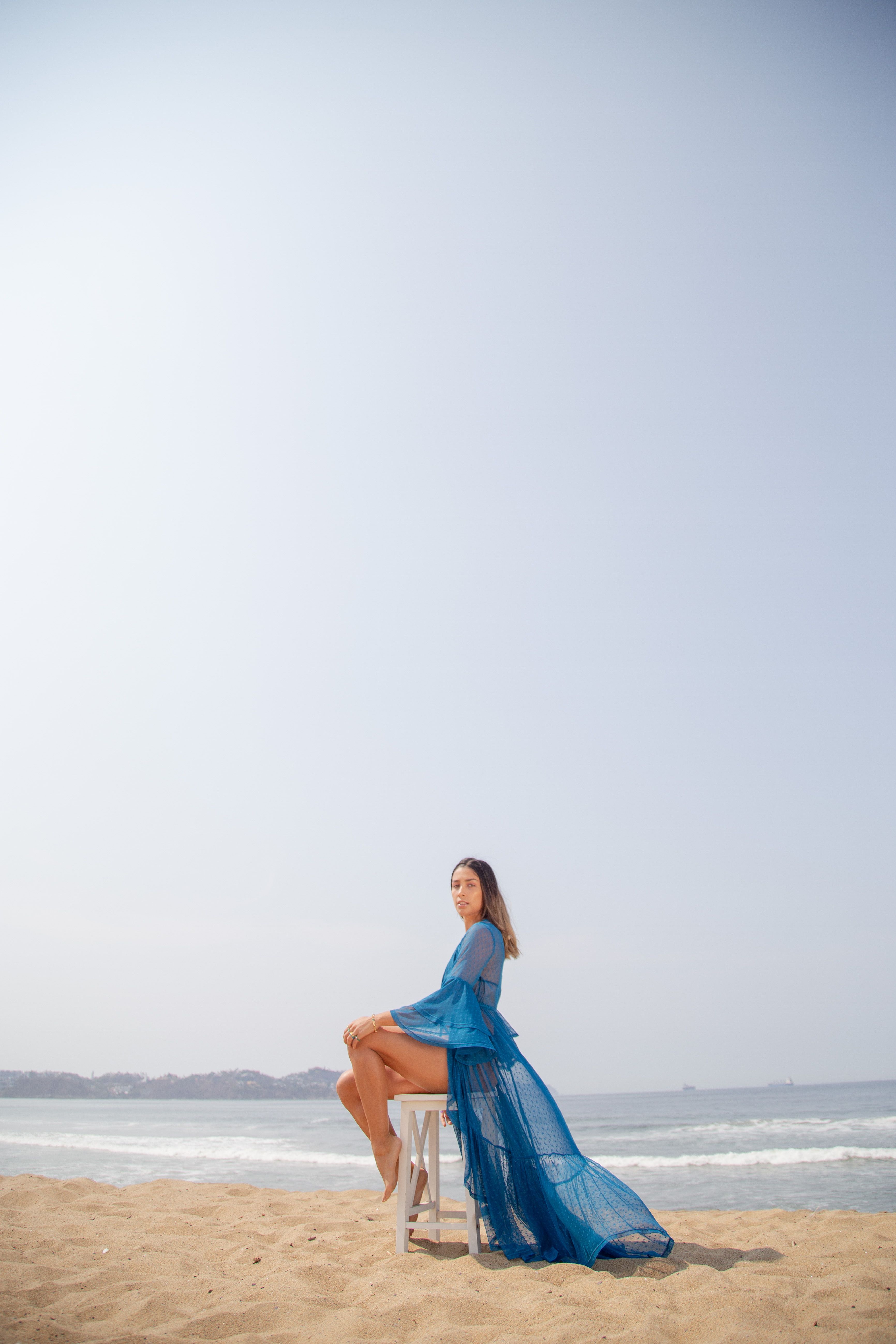 Woman Sitting on Stool While Looking Down · Free Stock Photo