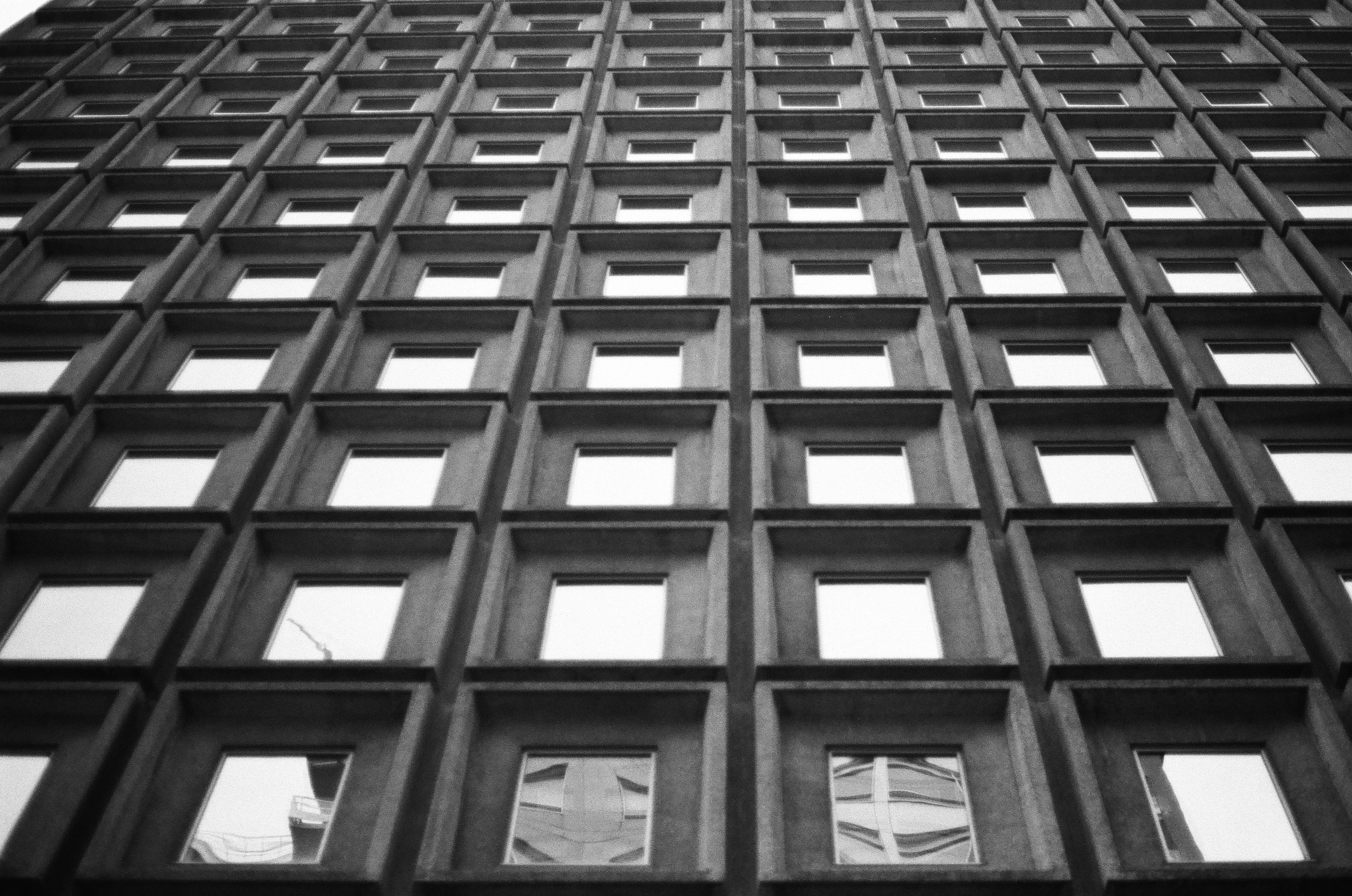 Grayscale Photo of Building Windows · Free Stock Photo