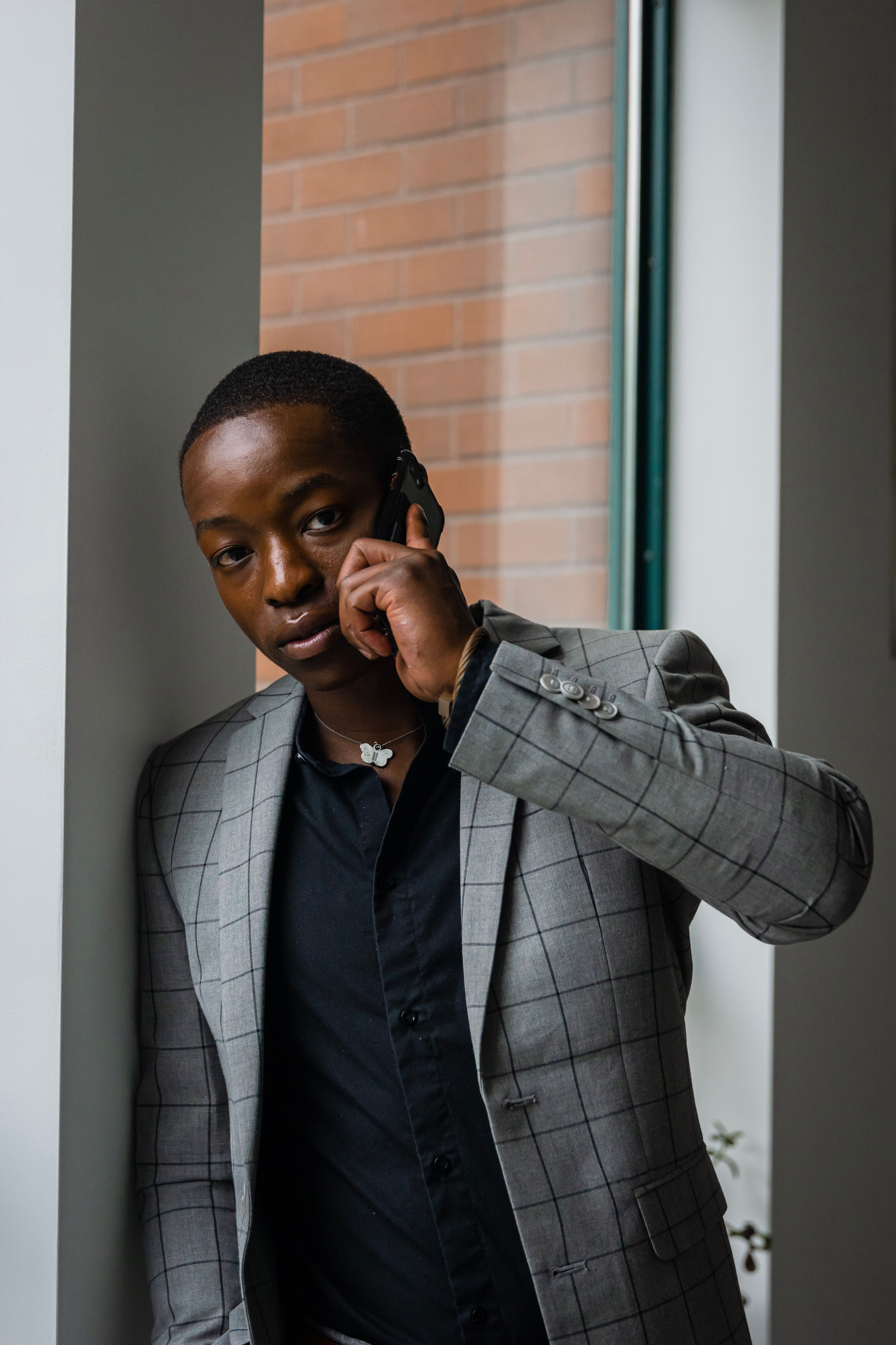 A Man in a Checkered Suit Having a Phone Call · Free Stock Photo
