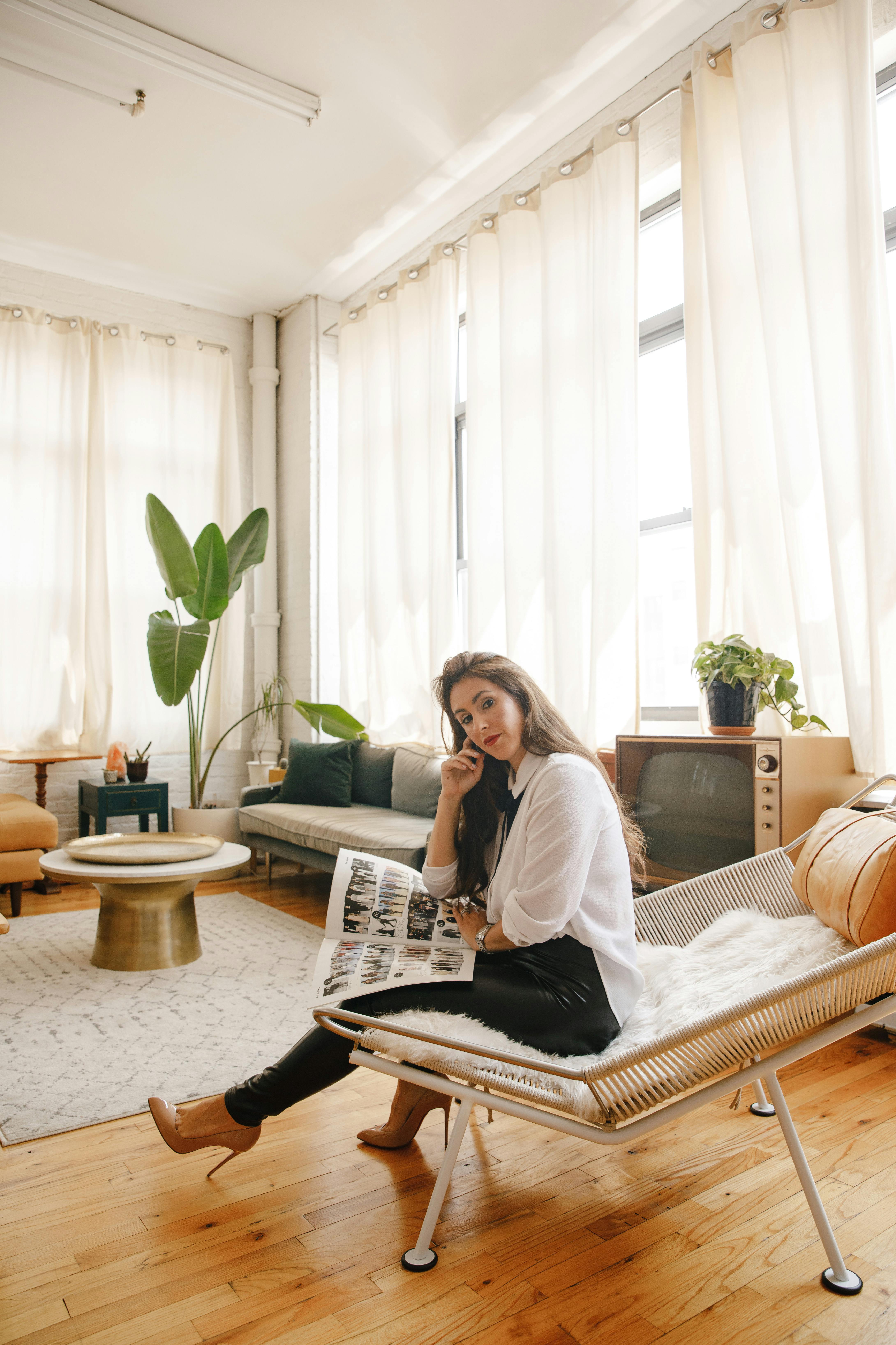 Woman Sitting on a Chair Inside a Hotel Room · Free Stock Photo