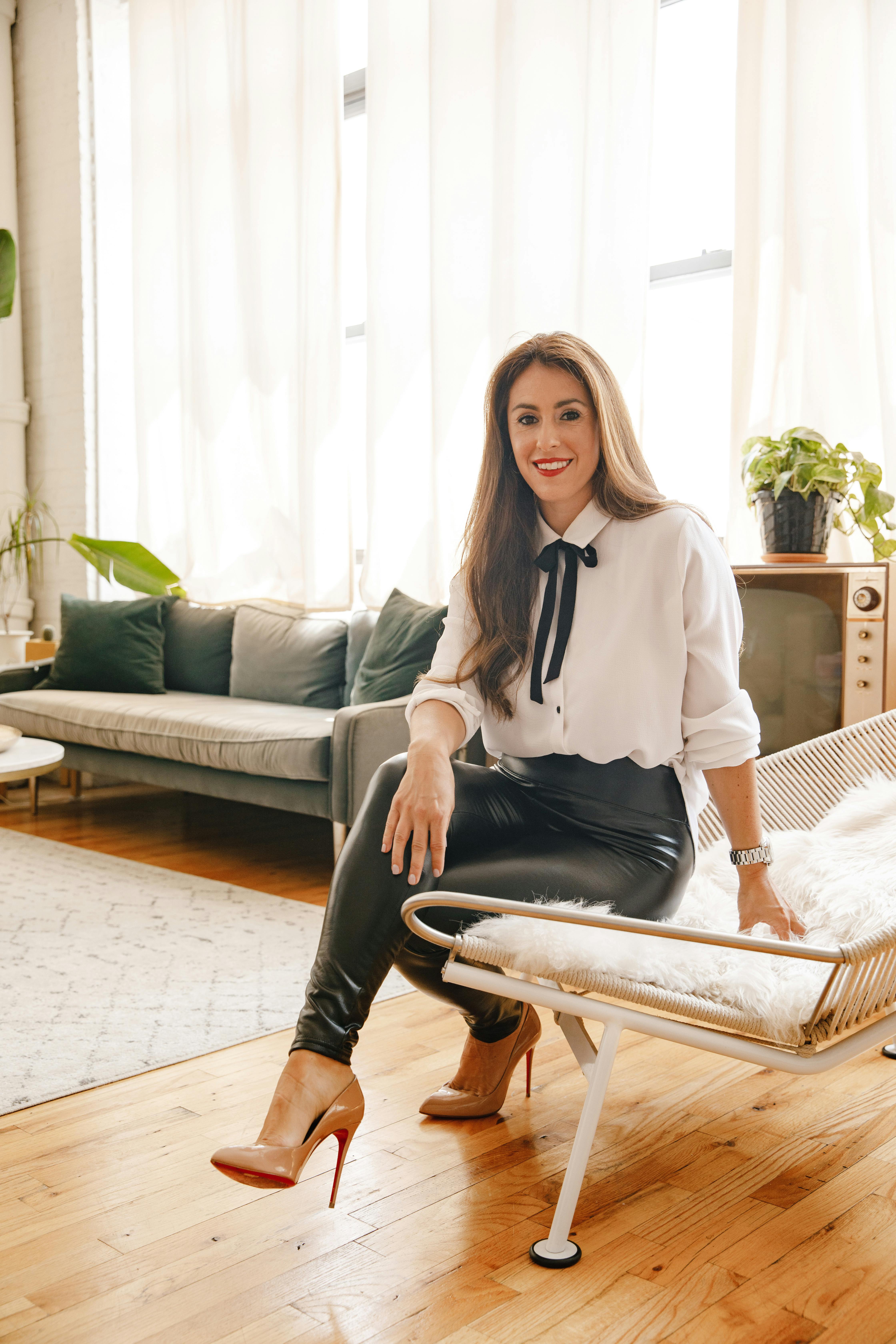 Woman in Black Pants Sitting on Brown Wooden Framed Gray Padded Couch ...