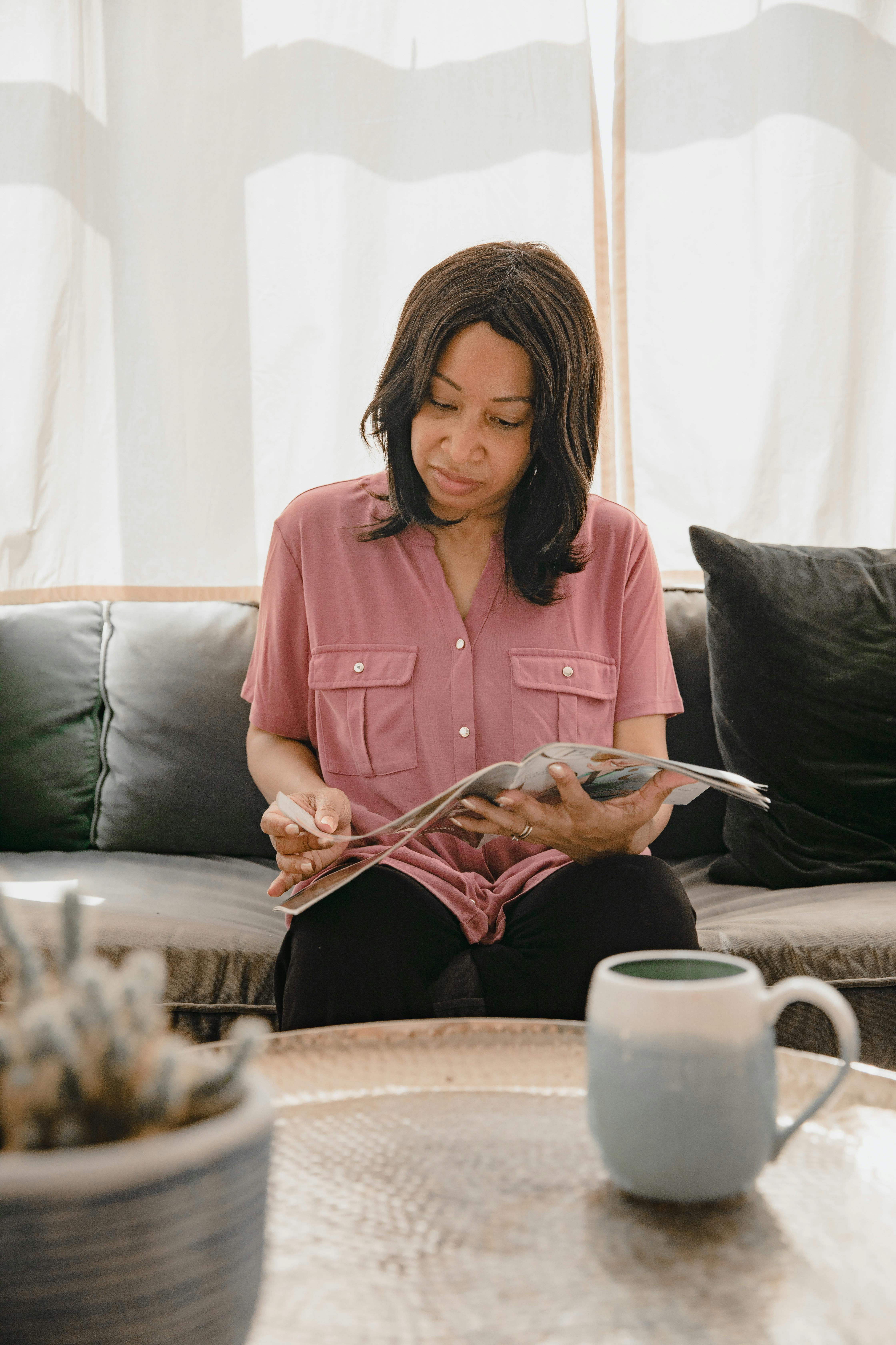 Unknown Person Pointing at Magazine · Free Stock Photo