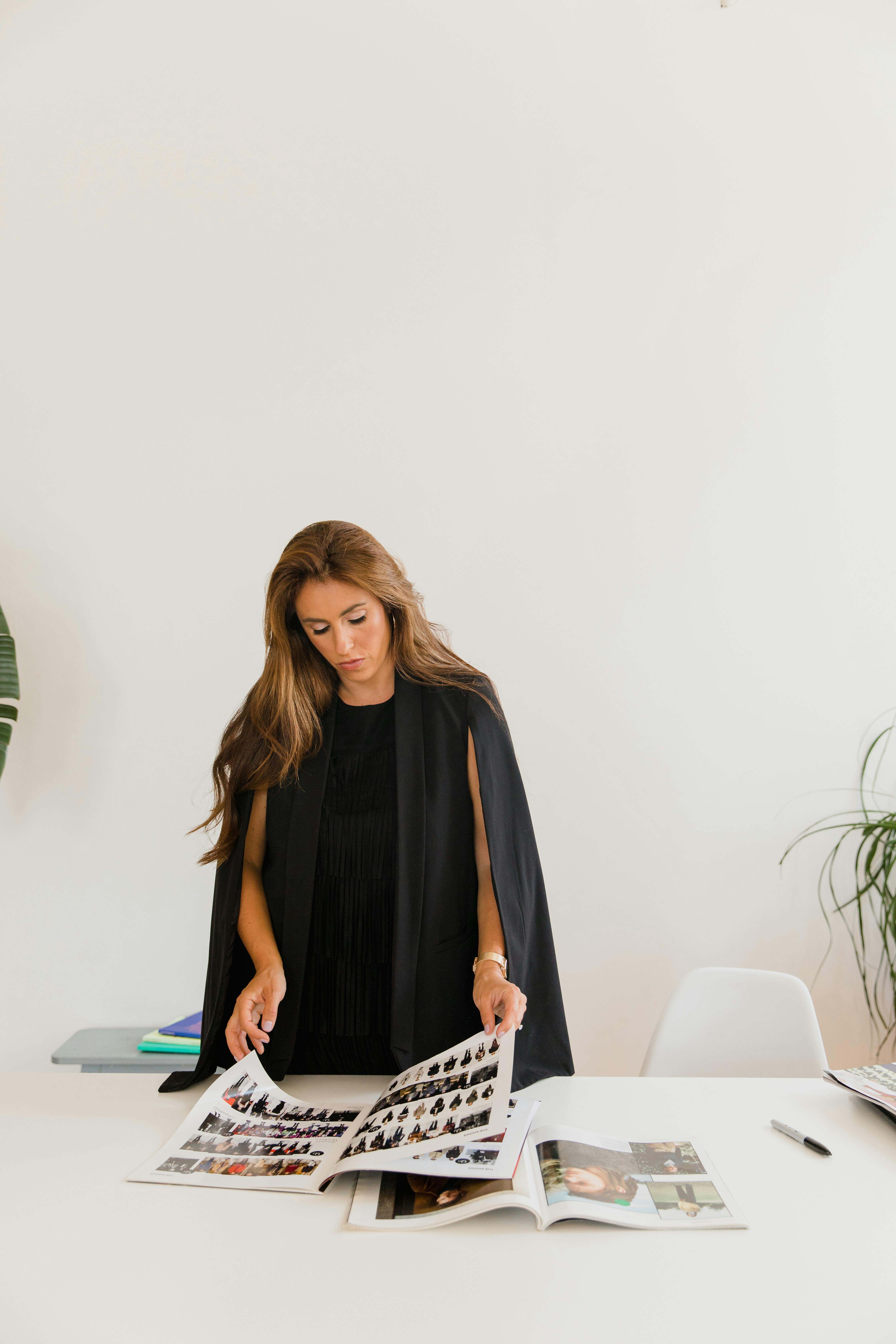 A Woman Flipping the Pages of a Magazine · Free Stock Photo