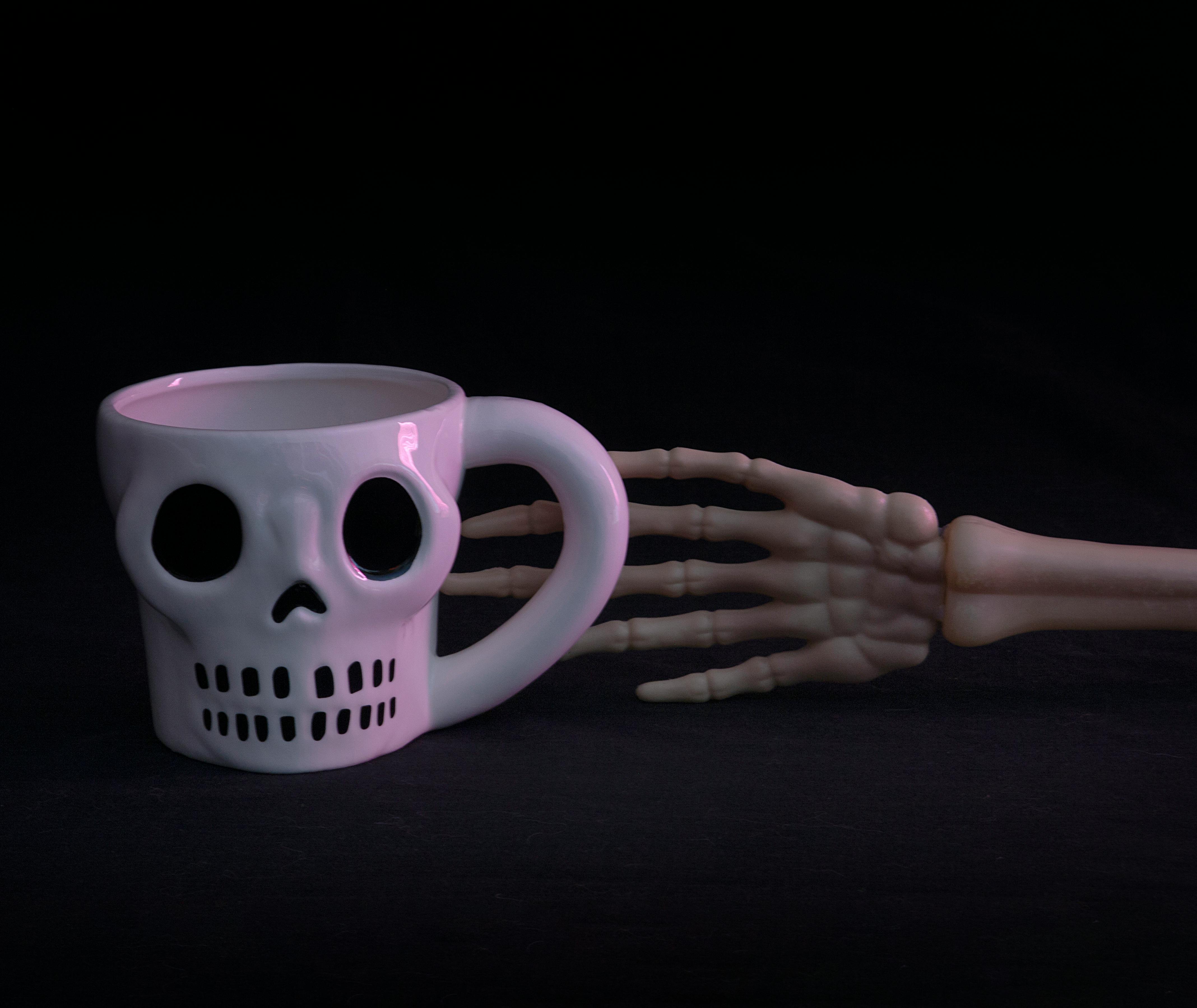 Skull Shaped Mug and a Skeleton Hand · Free Stock Photo