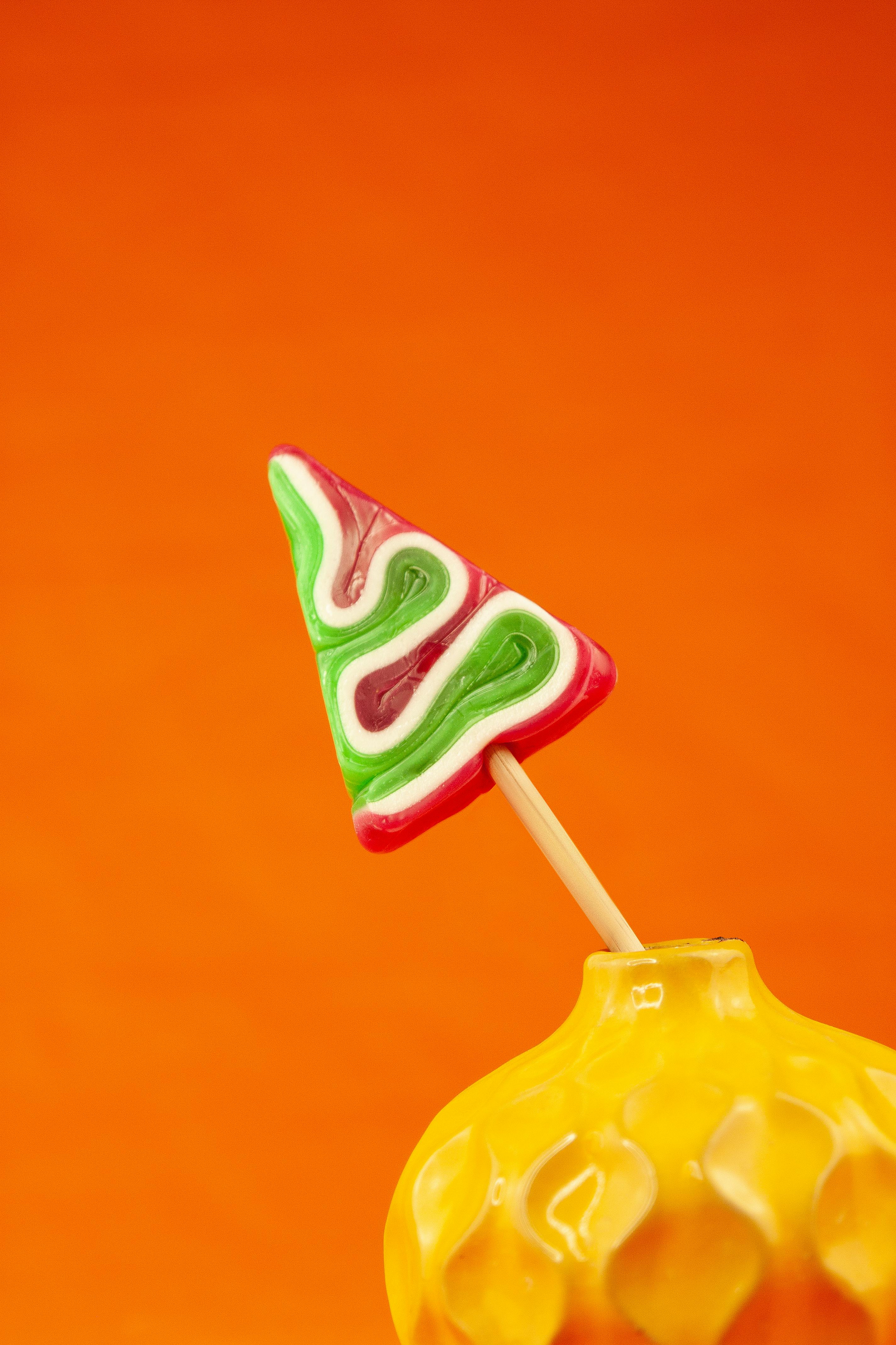 Triangle Lollipop on a Yellow Vase · Free Stock Photo