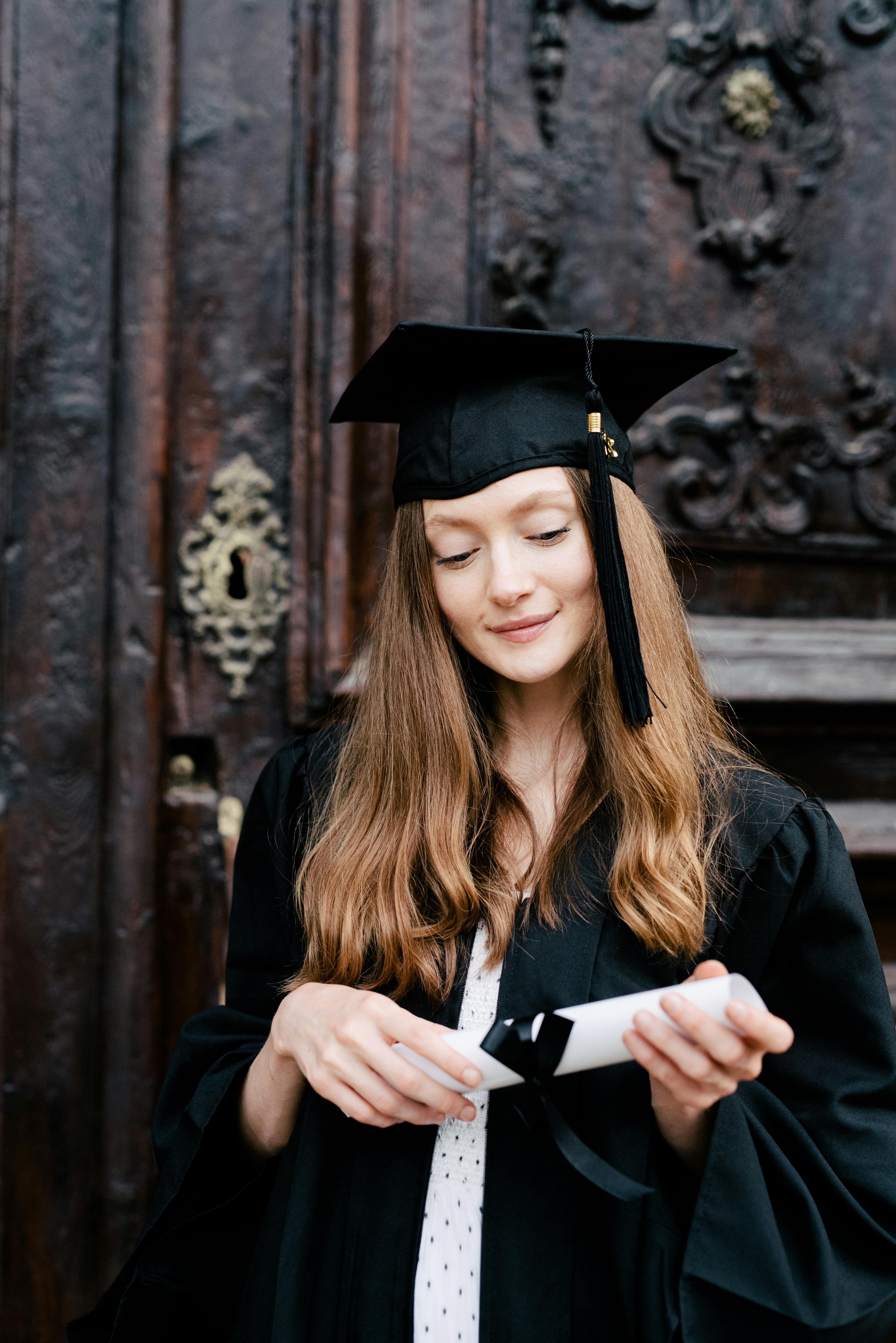 Portrait of Woman in Black Academic Dress · Free Stock Photo
