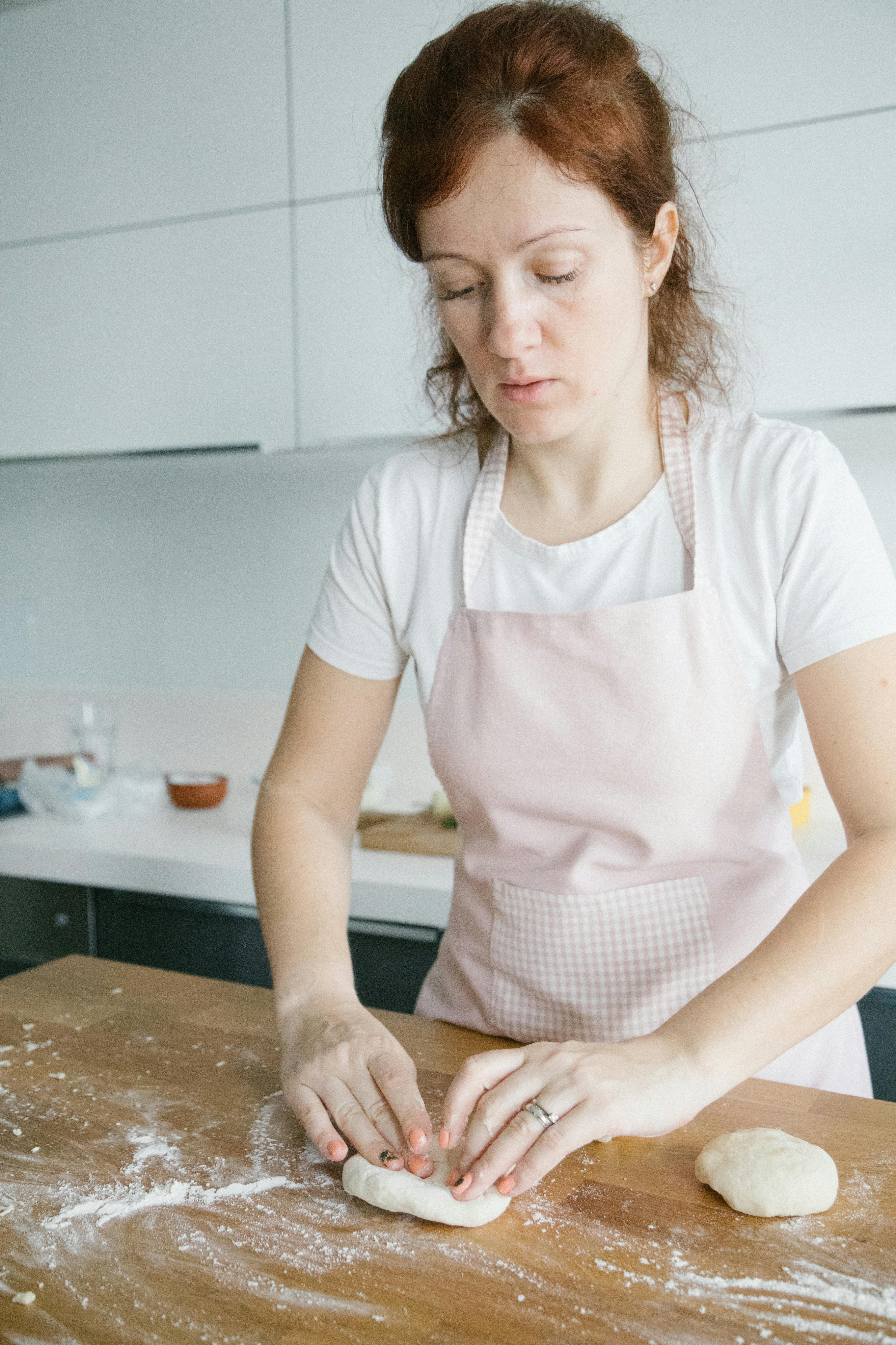 Happy woman with rolling pin cooking at home · Free Stock Photo