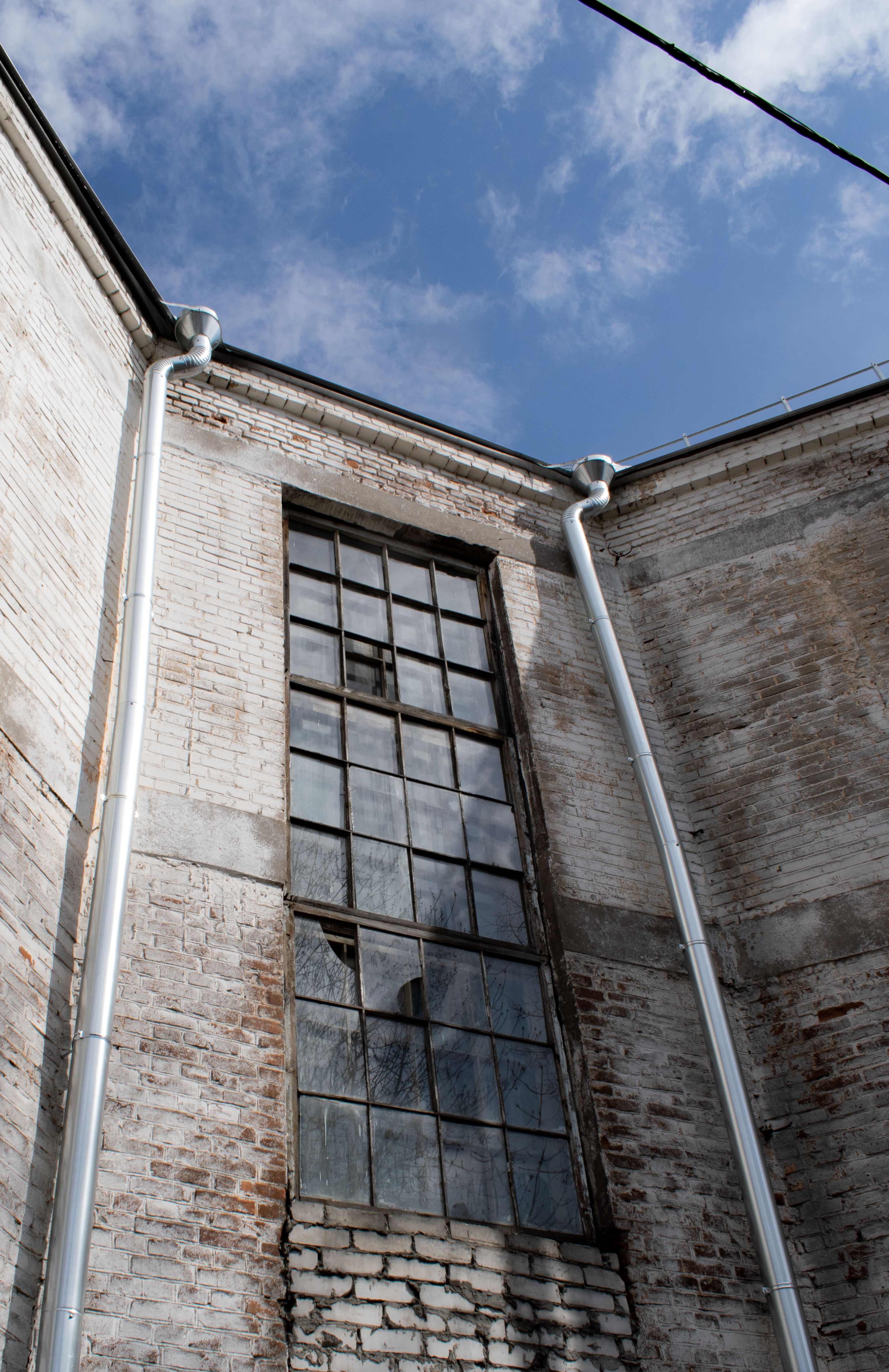 Brick Wall with Broken Glass Windows · Free Stock Photo
