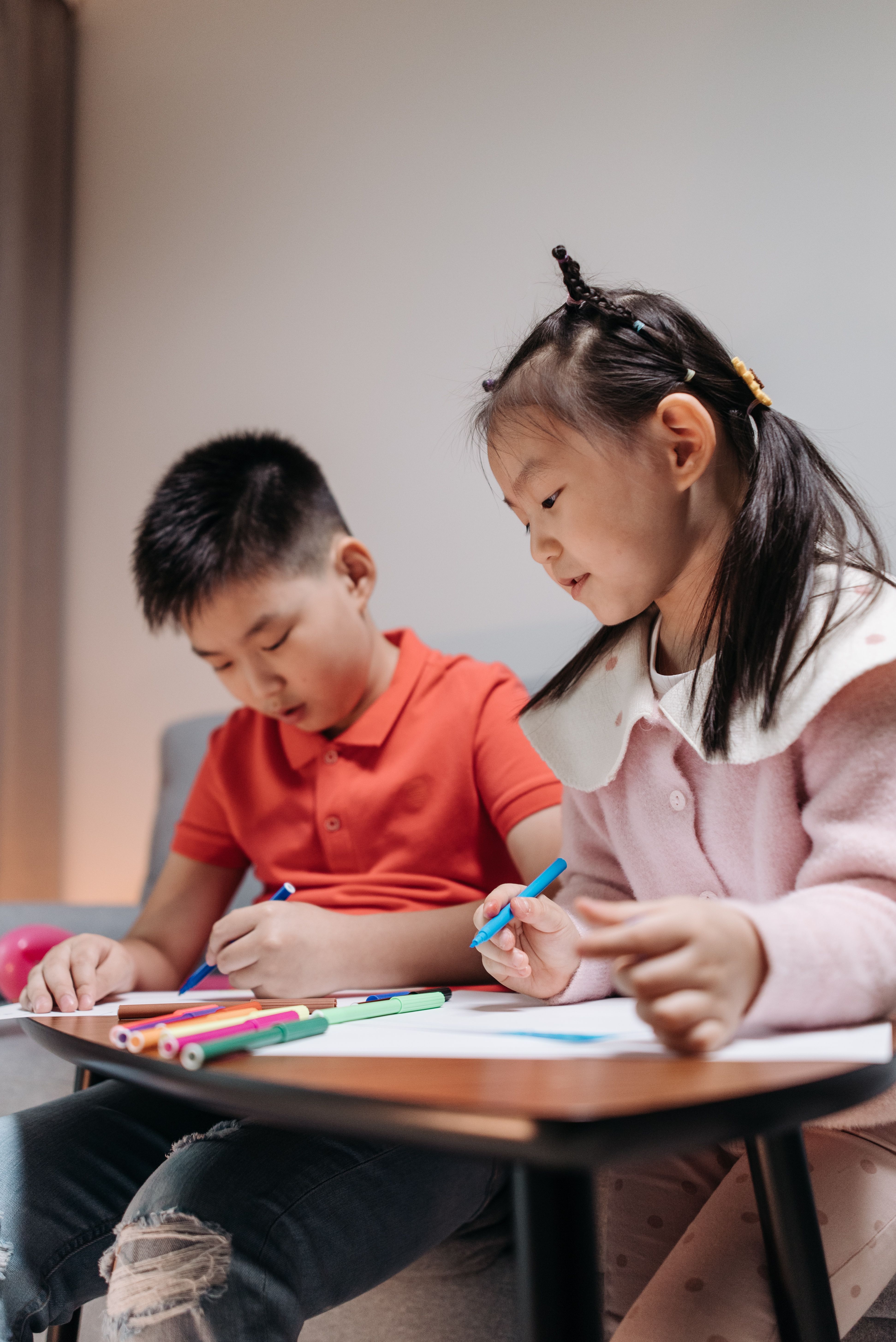 Kids Drawing on a Paper Using Colored Pens · Free Stock Photo