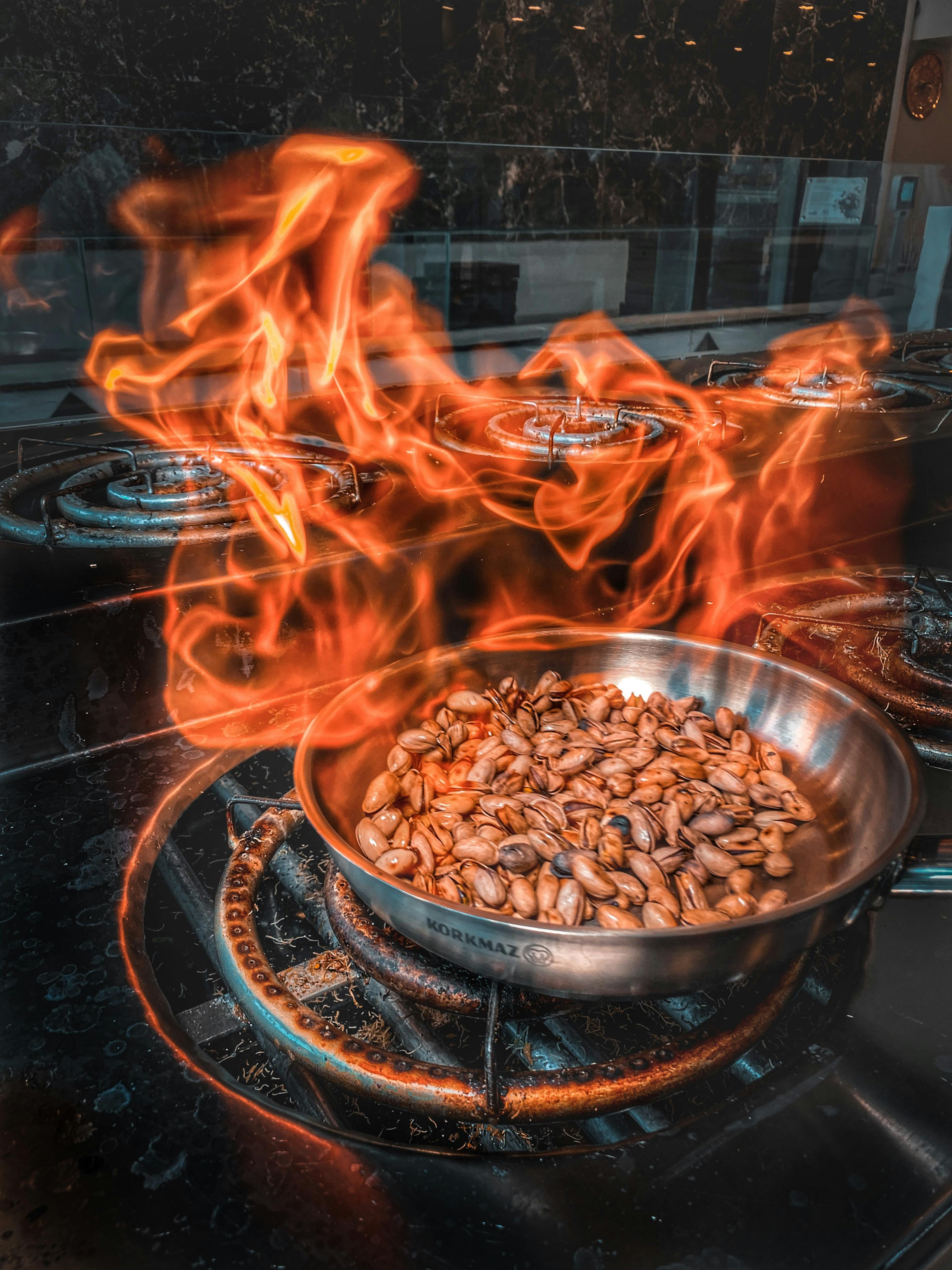 Nuts in a Burning Stainless Steel Frying Pan · Free Stock Photo