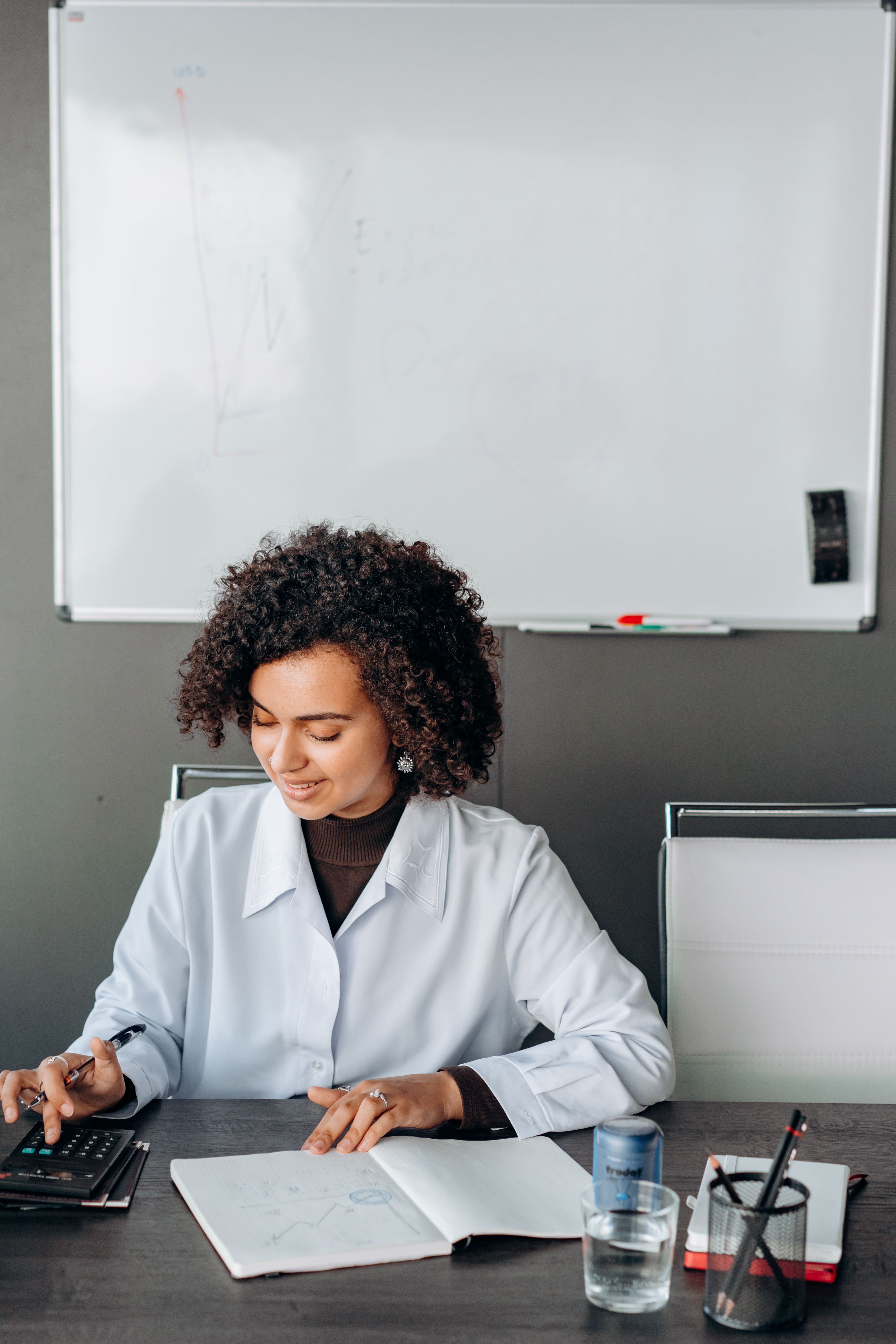 A Woman Using a Calculator · Free Stock Photo