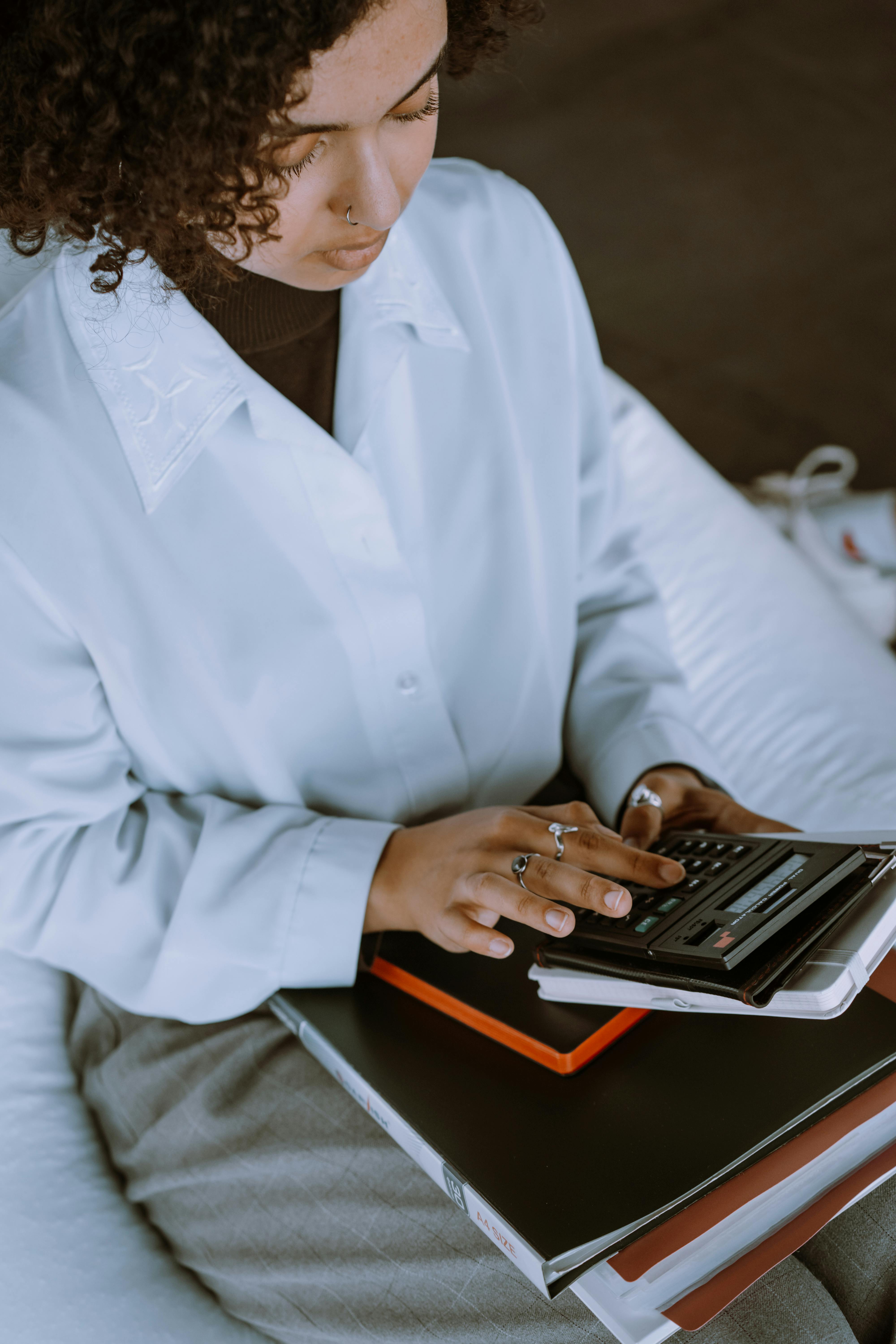 Woman Holding Black Calculator · Free Stock Photo